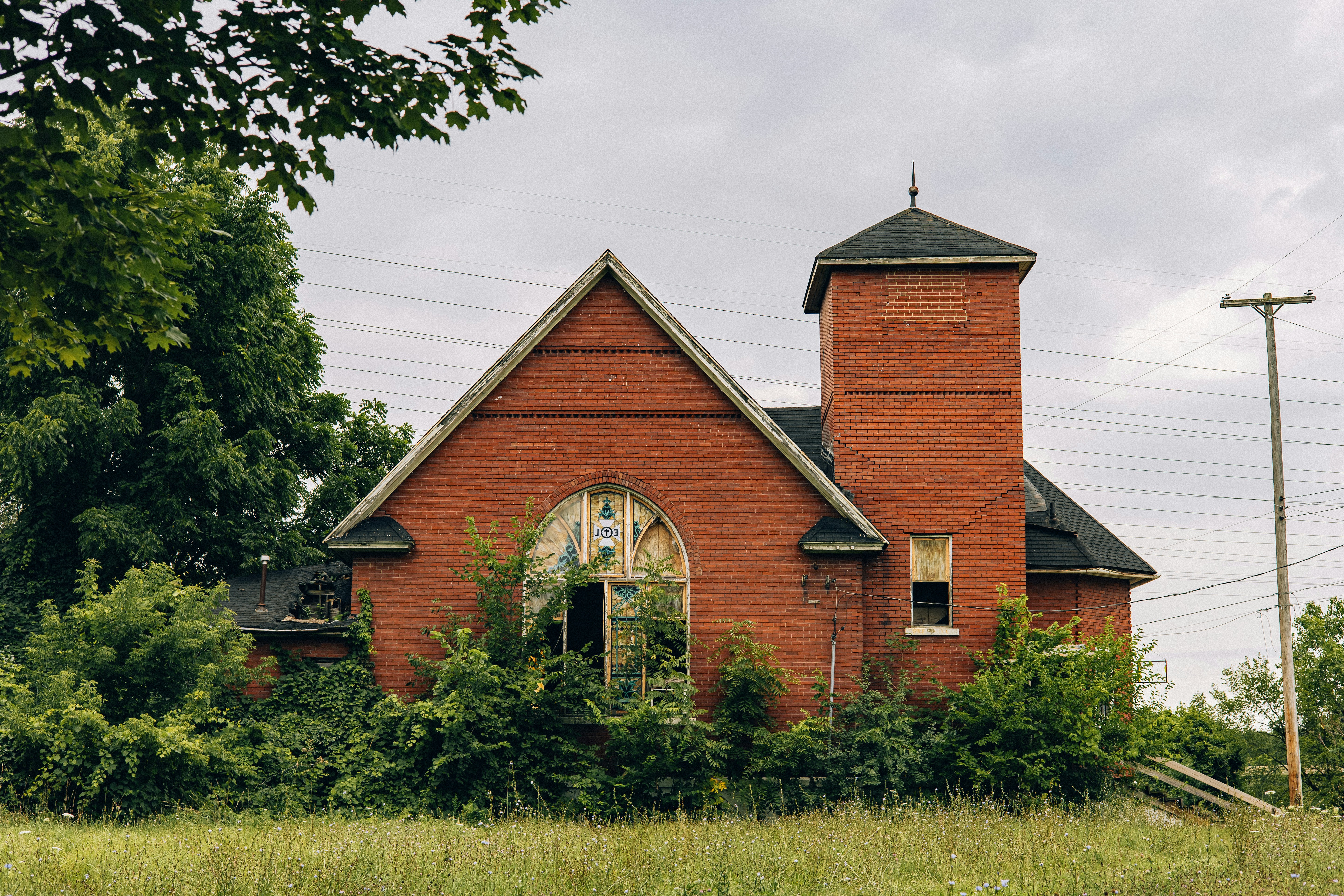 an old red brick church with a clock tower