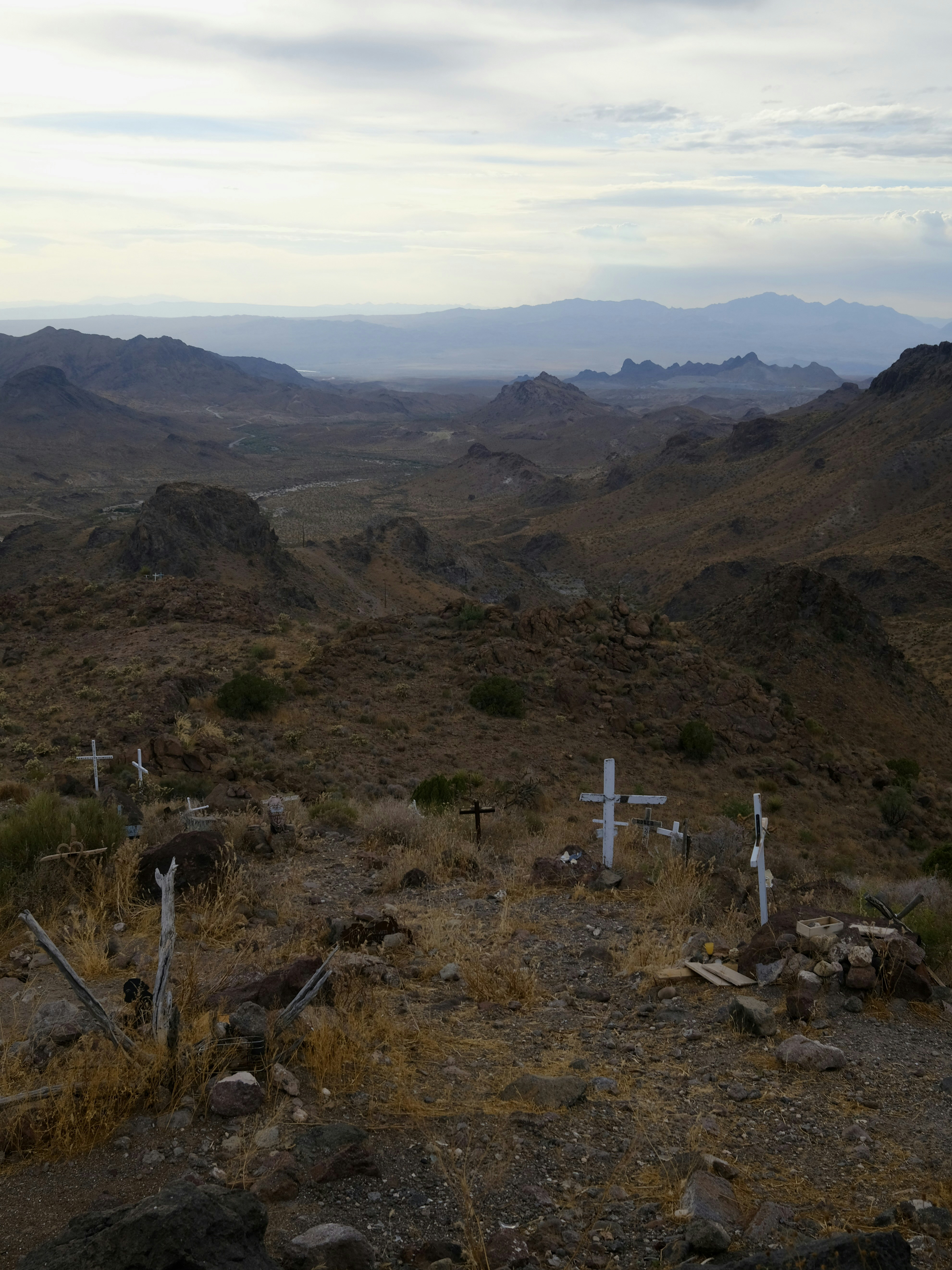 A view of a mountain range with crosses in the foreground photo – Free ...