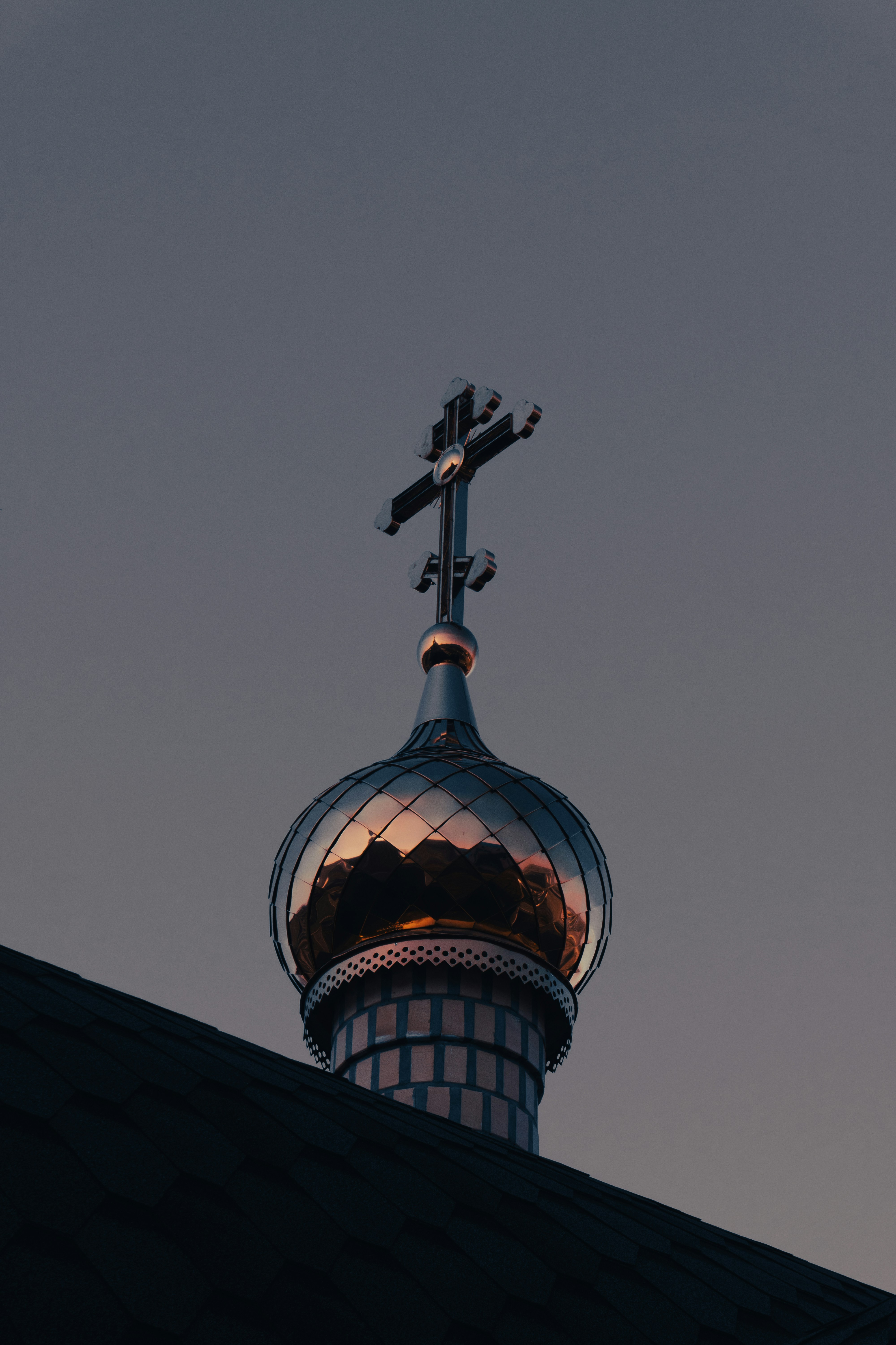 Dusk over a Copper Onion Dome: A Quiet Sentinel Above the Slate Roof