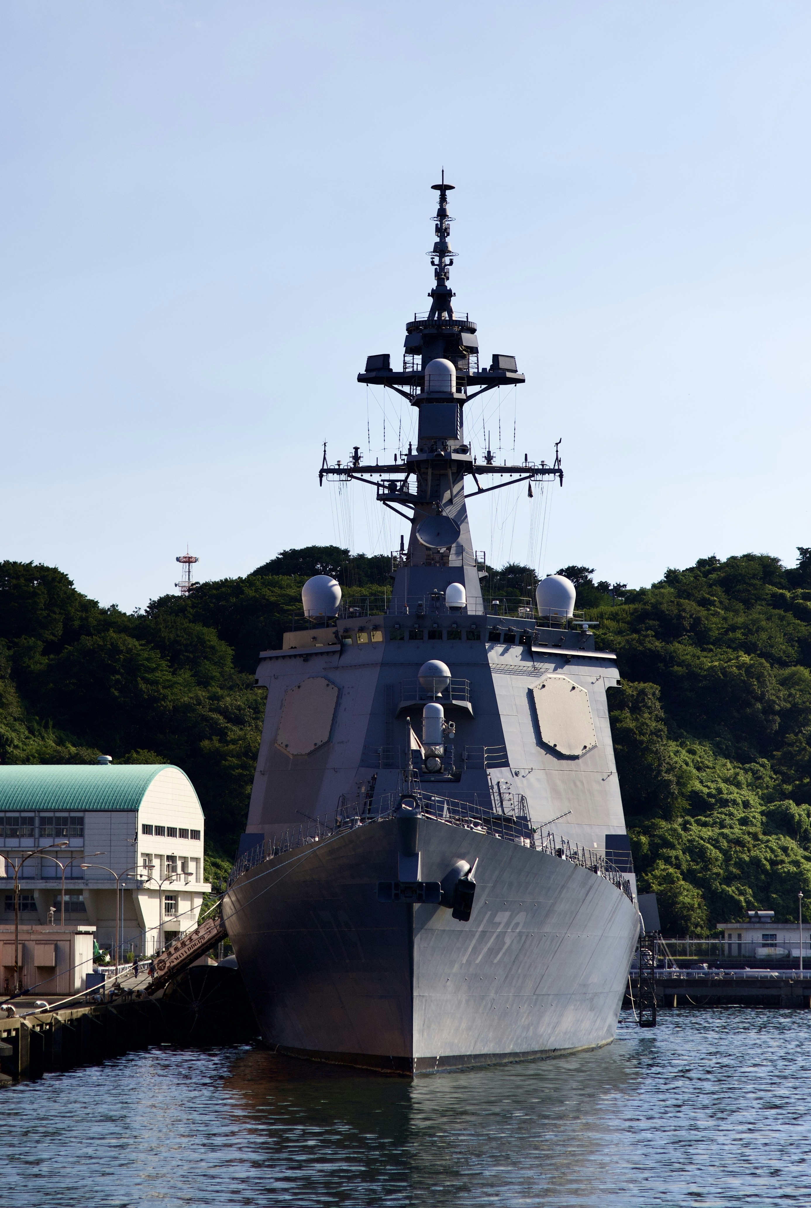 A large military ship docked at a dock photo – Free Military Image on ...