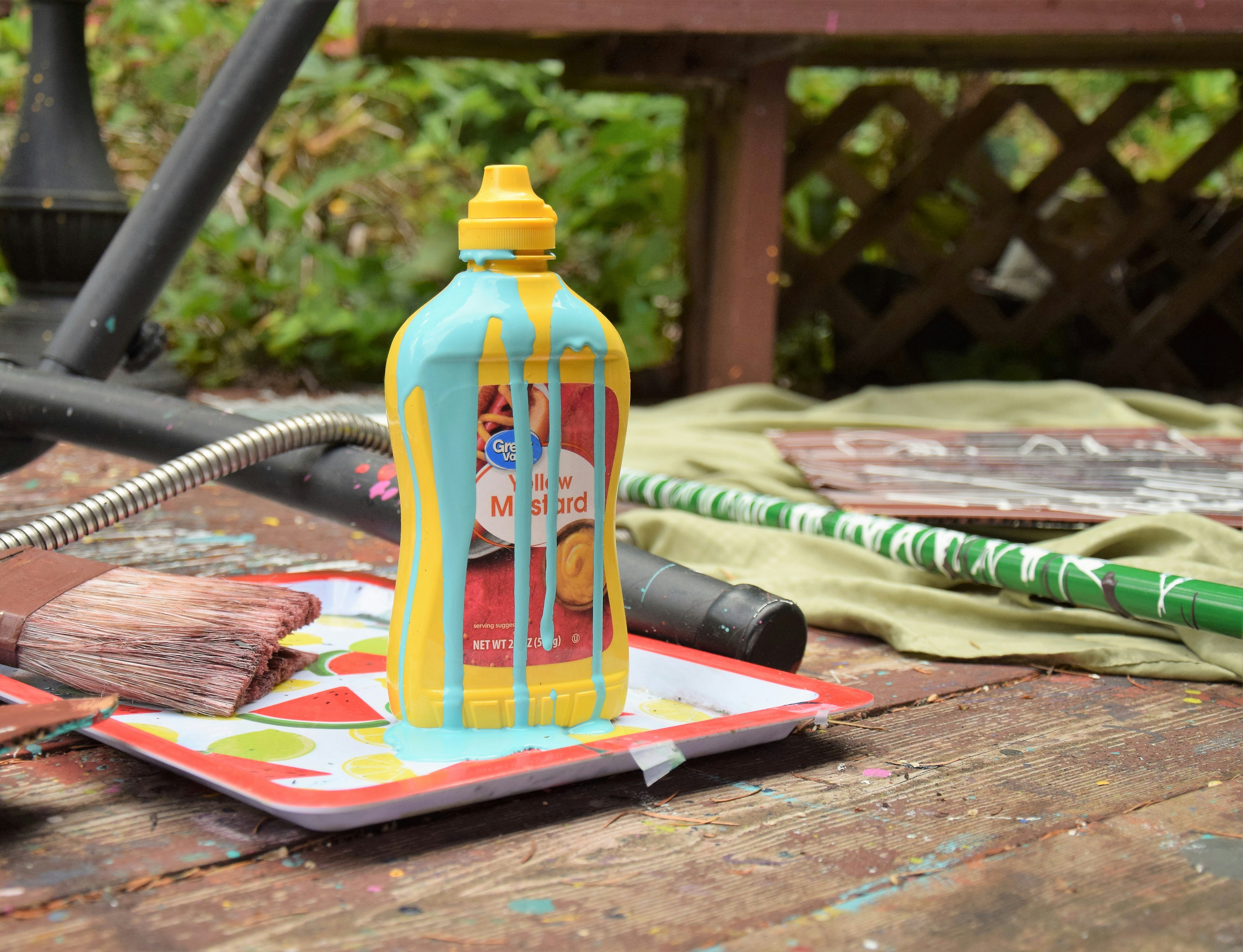 Drips on the Deck: A Colorful Mustard Bottle Anchors an Outdoor Painting Setup