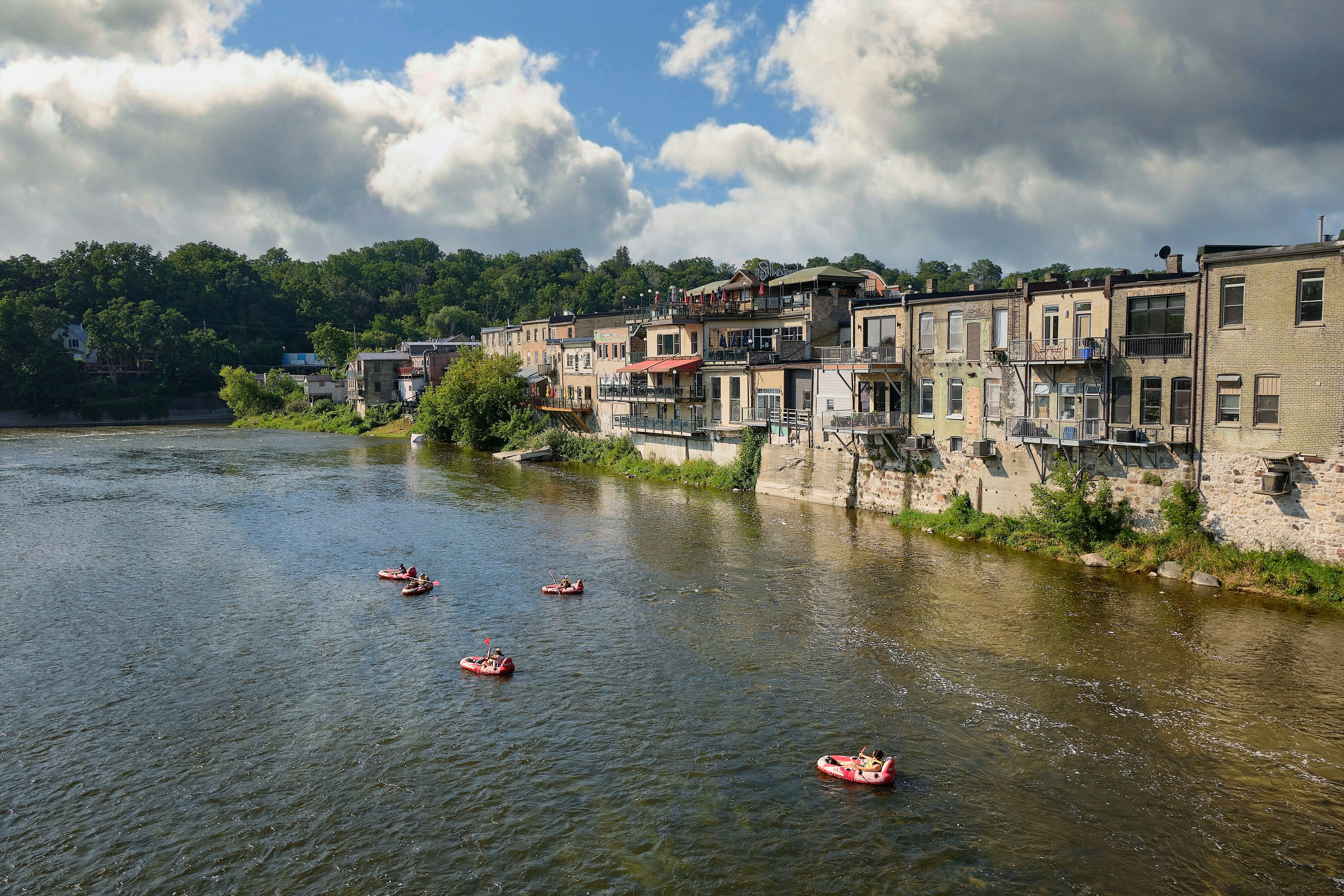 A group of boats floating on top of a river photo – Free Water Image on ...