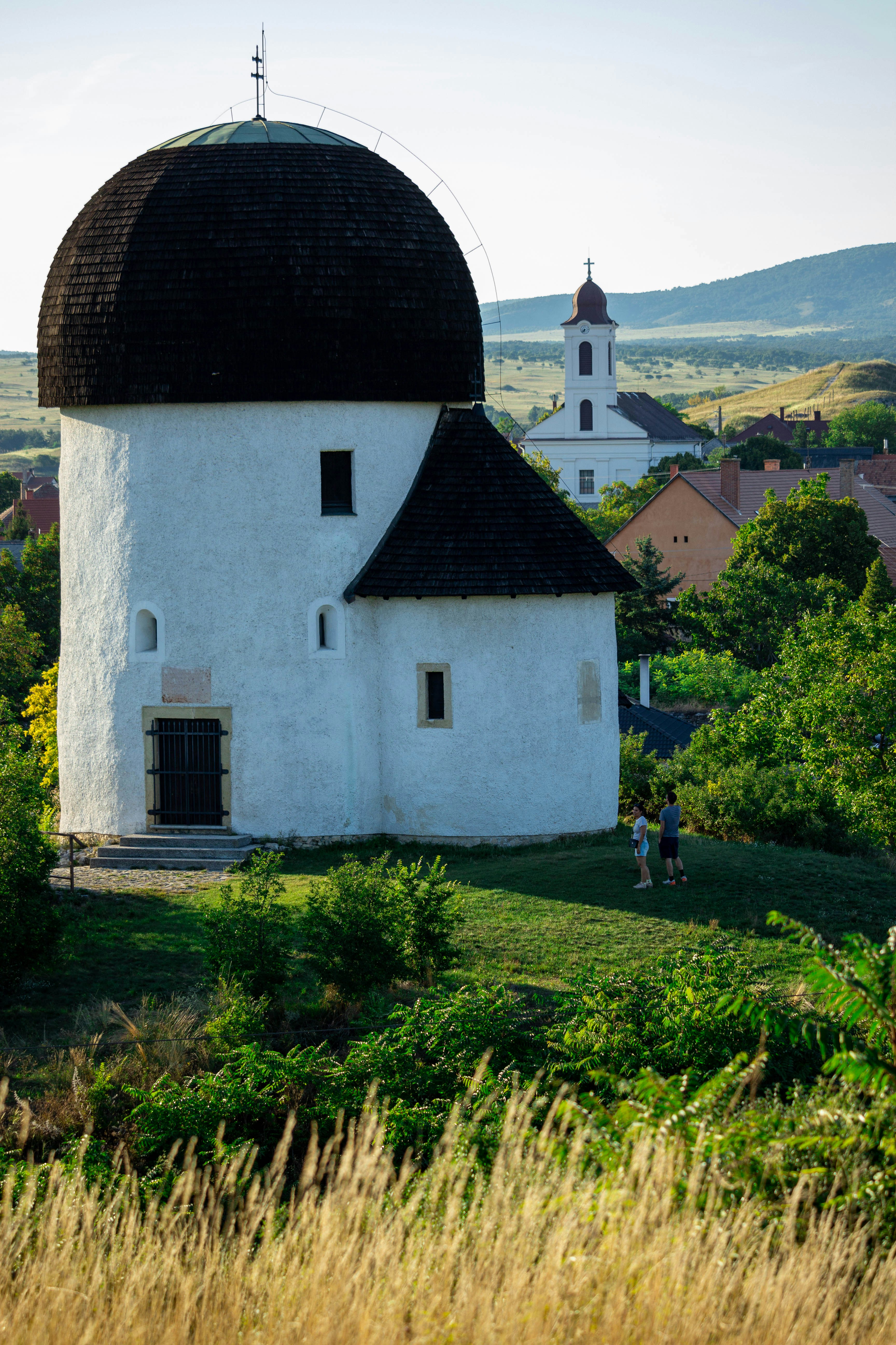 Dome-Topped White Tower Over a Sunlit Hillside Village