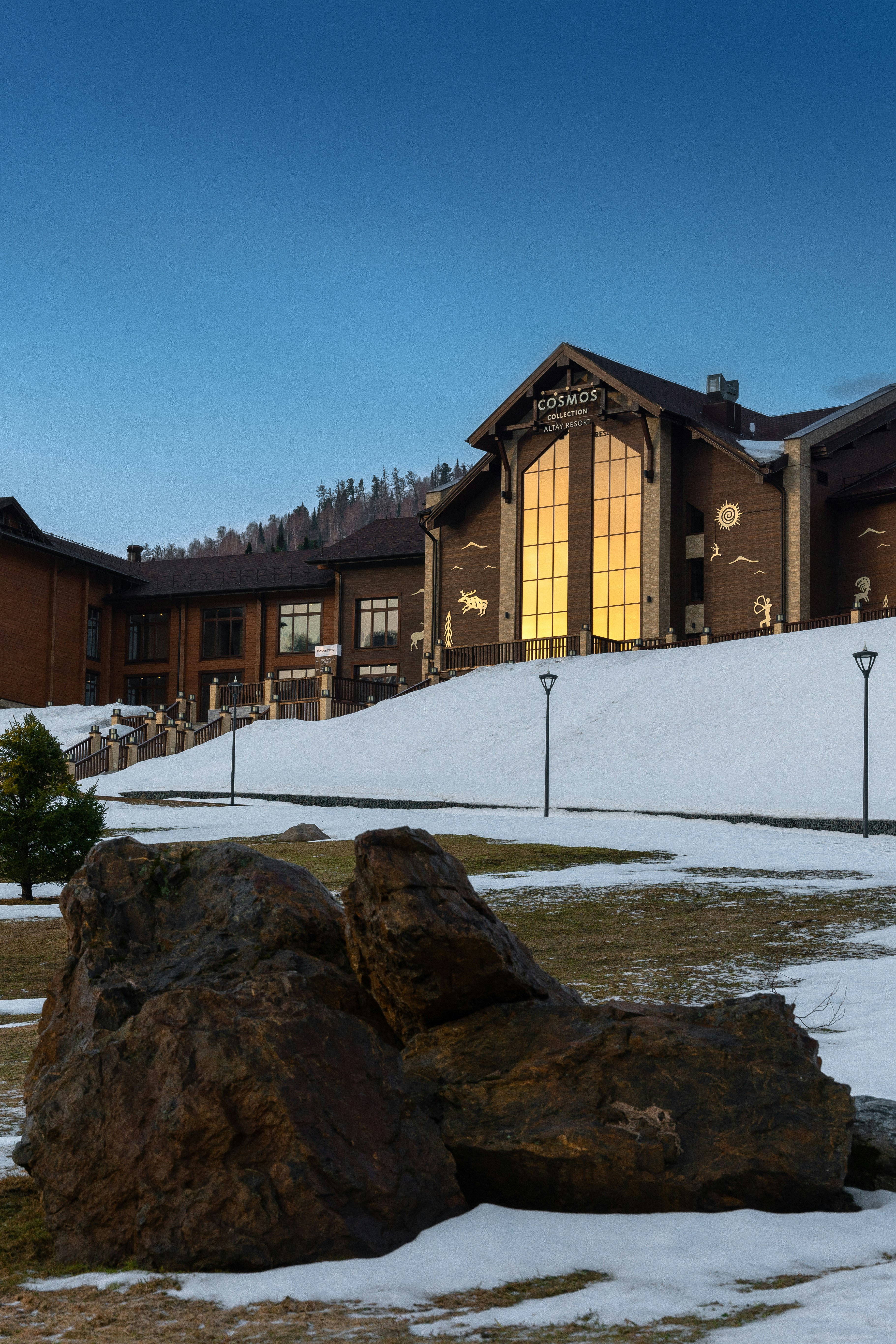 Cosmos Lodge Summit: Golden Facade Rising Over Snow