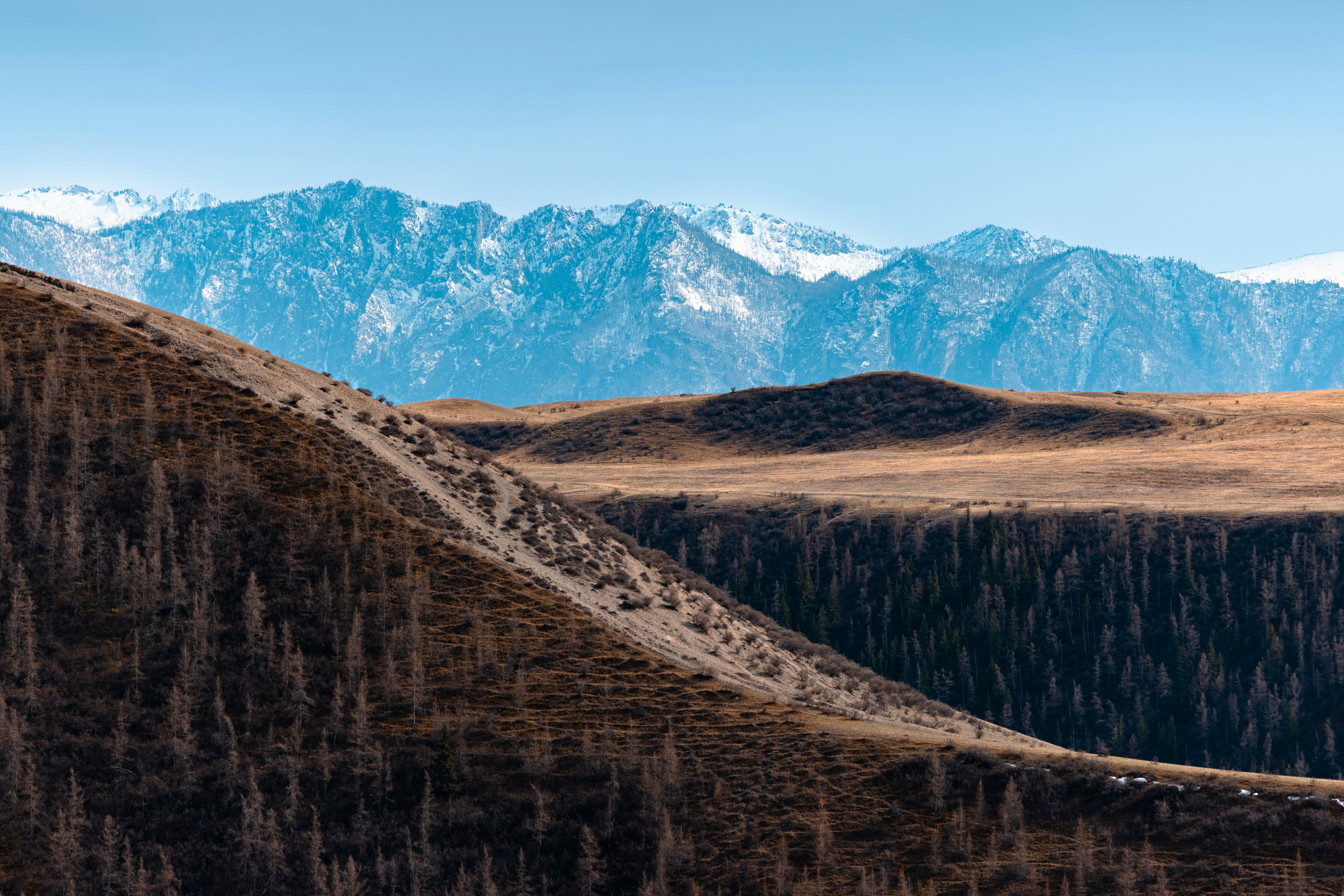 A view of a mountain range from a distance photo – Free Mountains Image ...