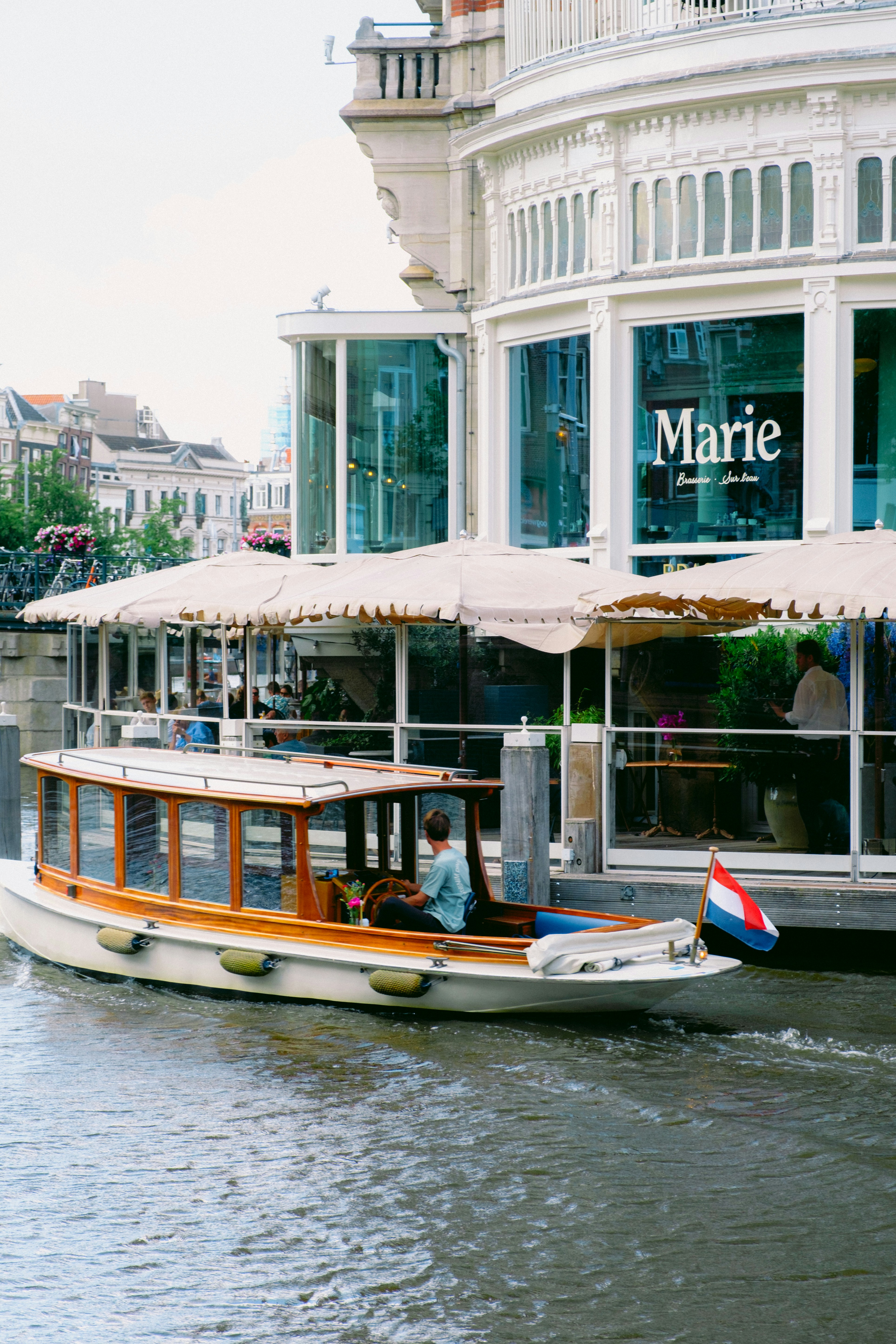 Canal Café by the Grand Palais: A Quiet Boat Glides by Café Windows