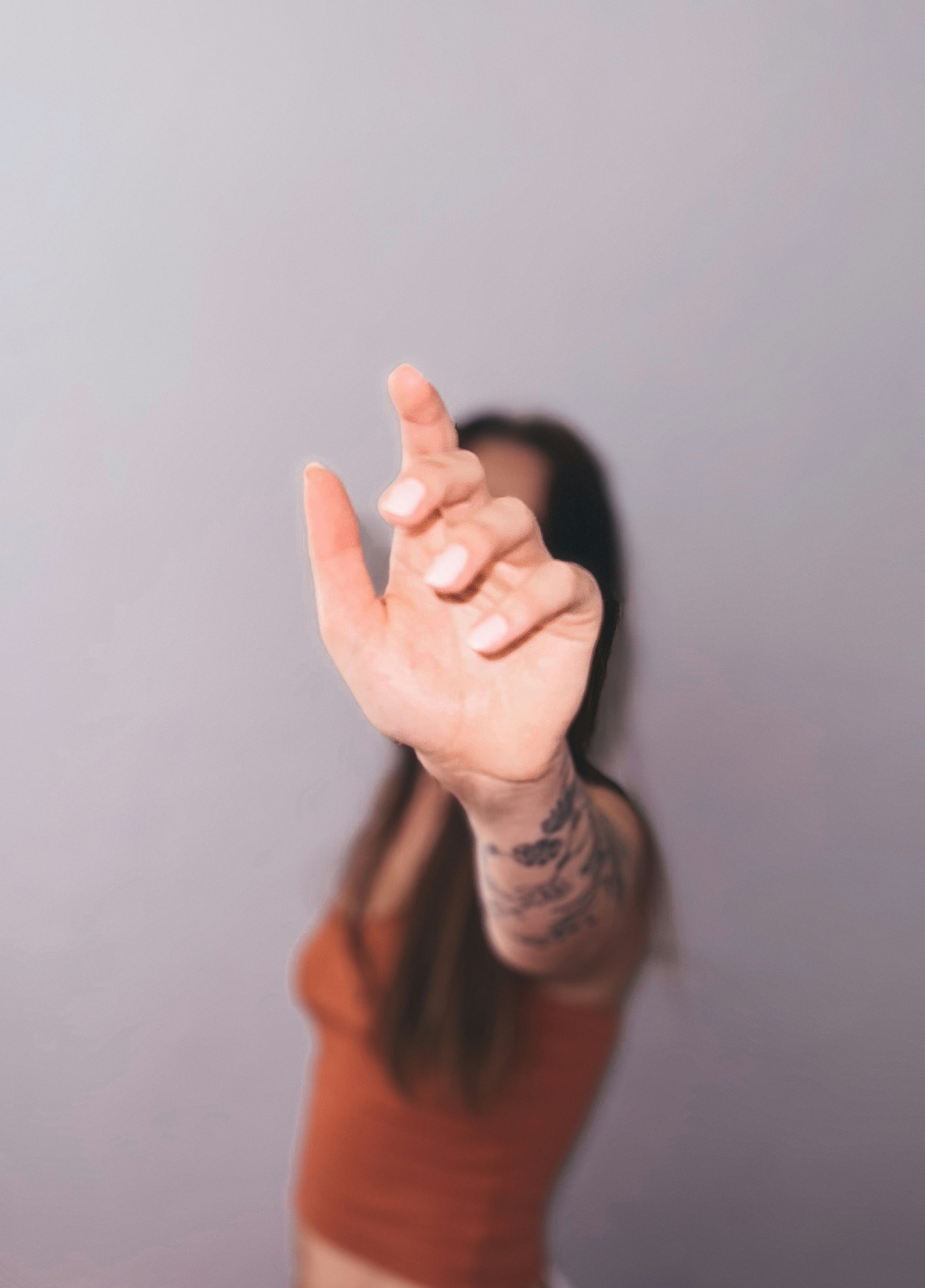 A woman making a hand sign with her fingers photo – Free Hand Image on ...