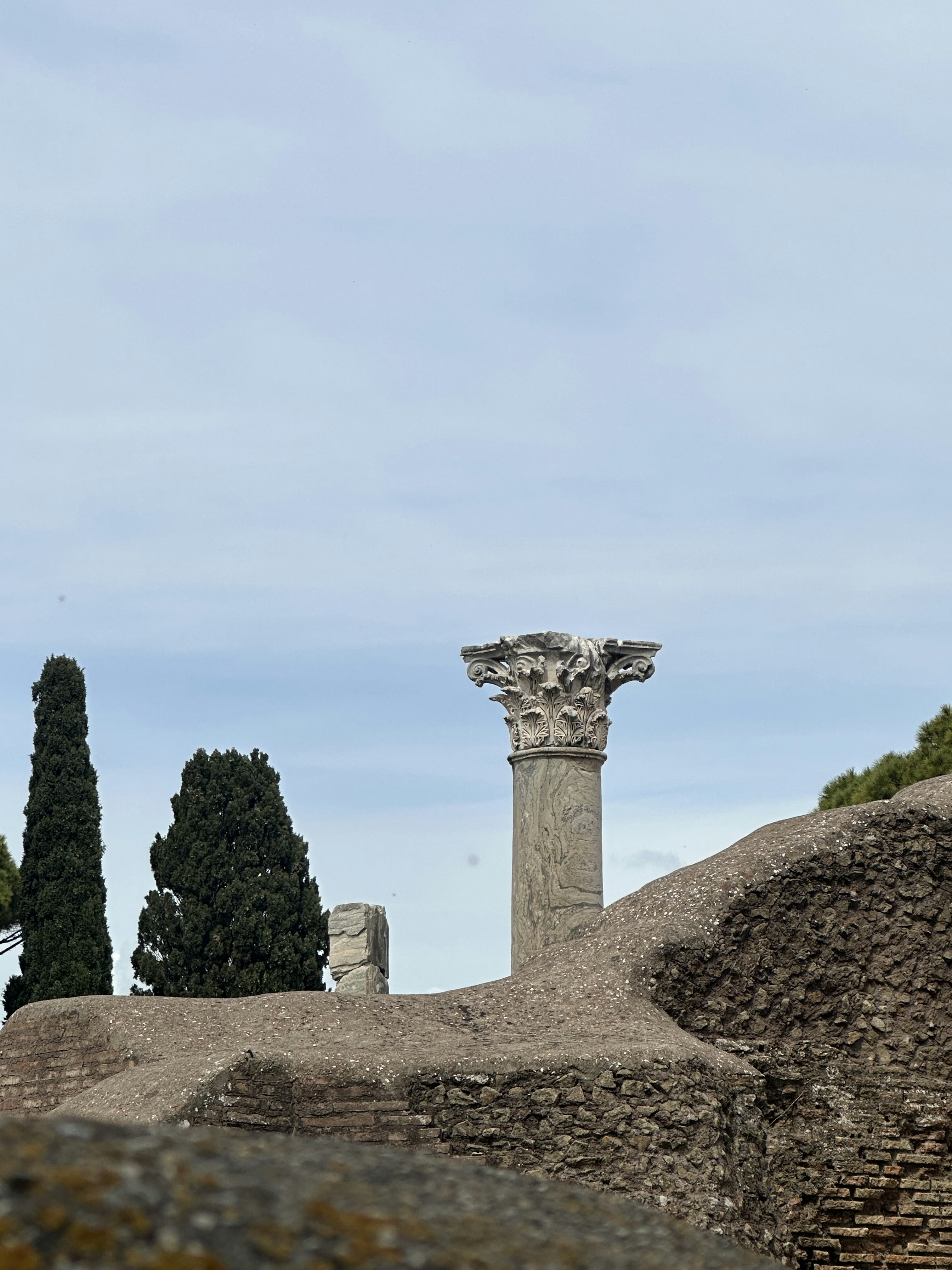 A stone pillar with a statue on top of it photo – Free Ruins Image on ...