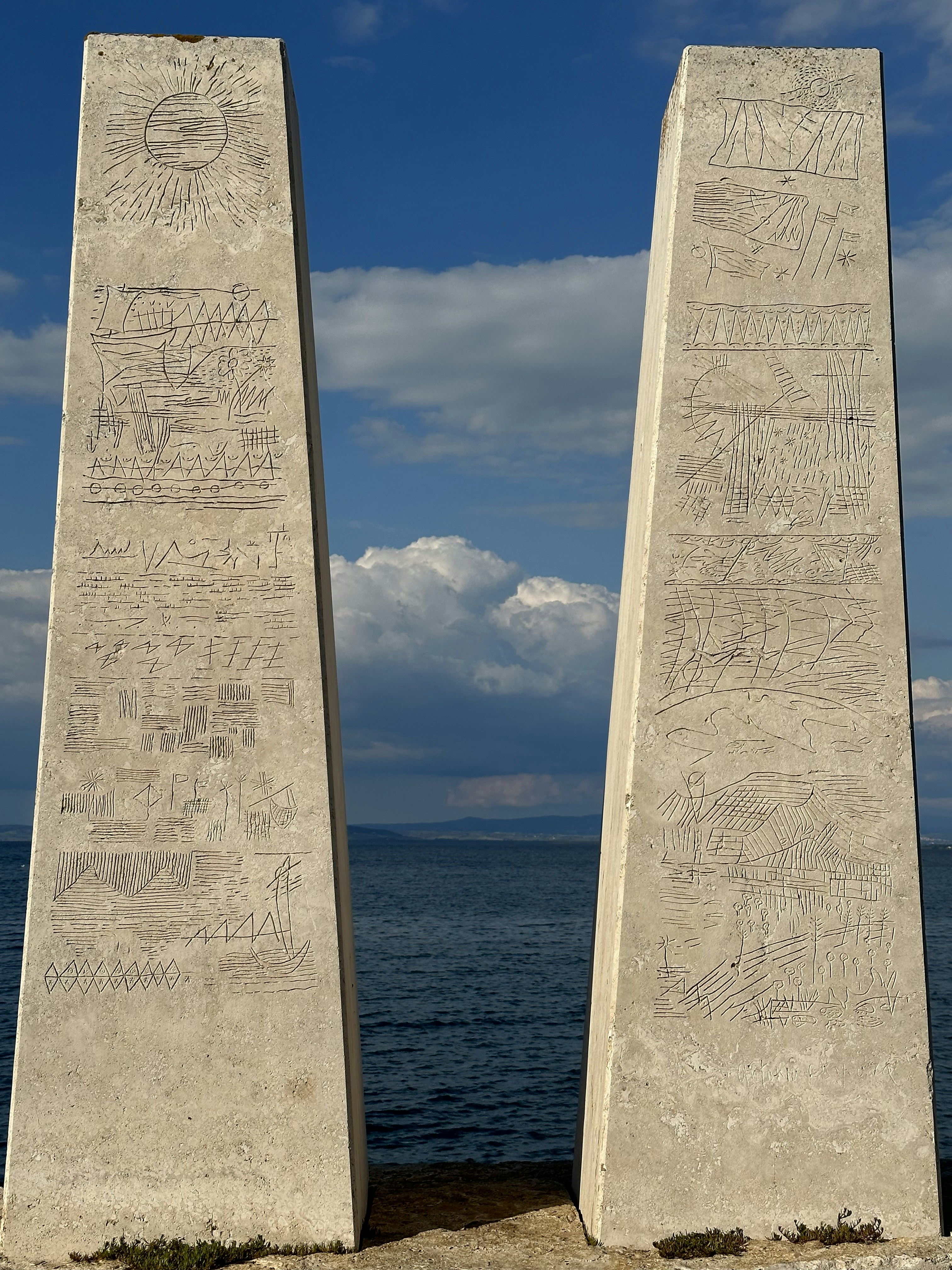 Two obelisk standing in front of a body of water photo – Free Iphone ...