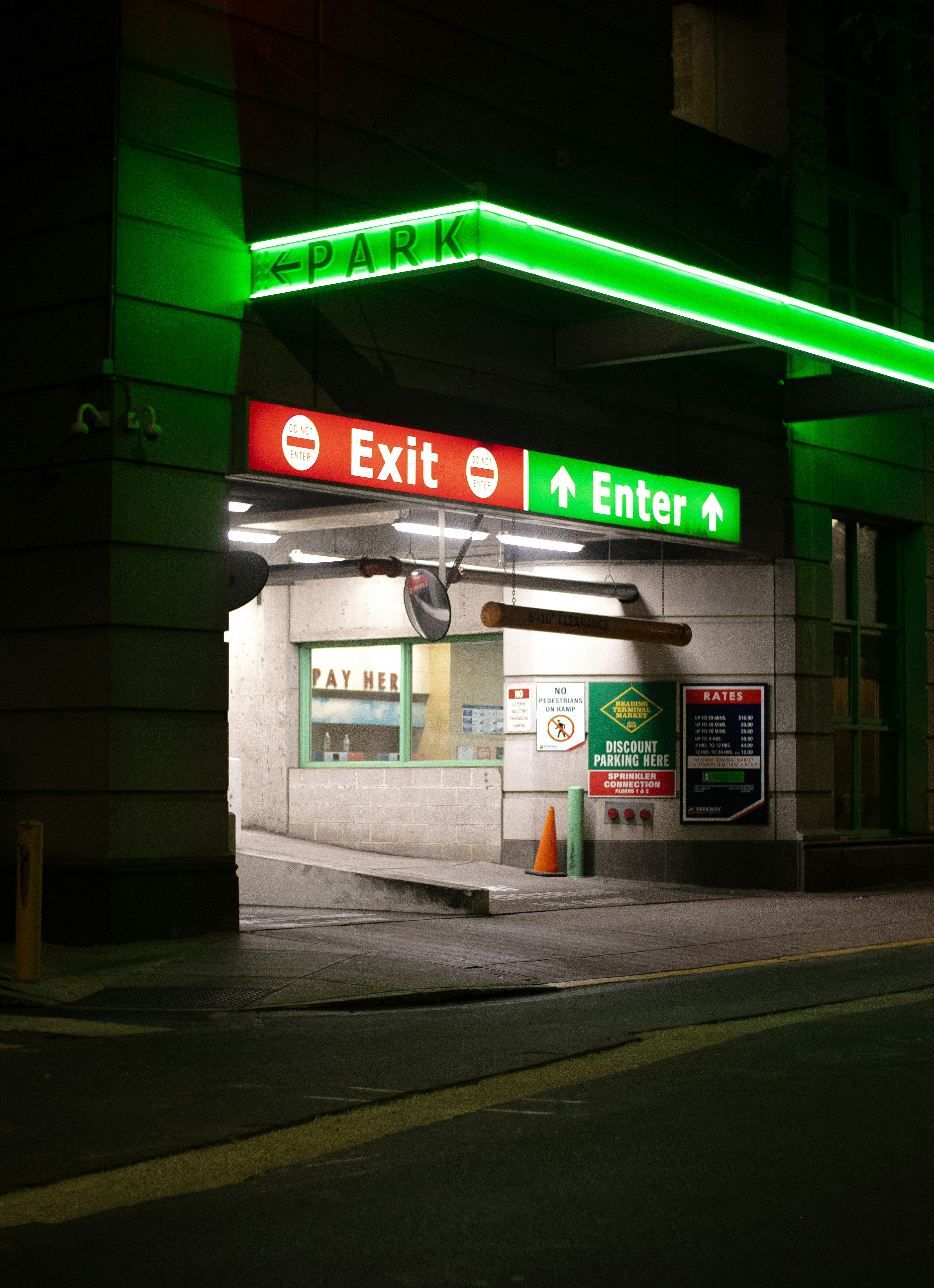 A lit up exit sign on the side of a building photo – Free Building ...