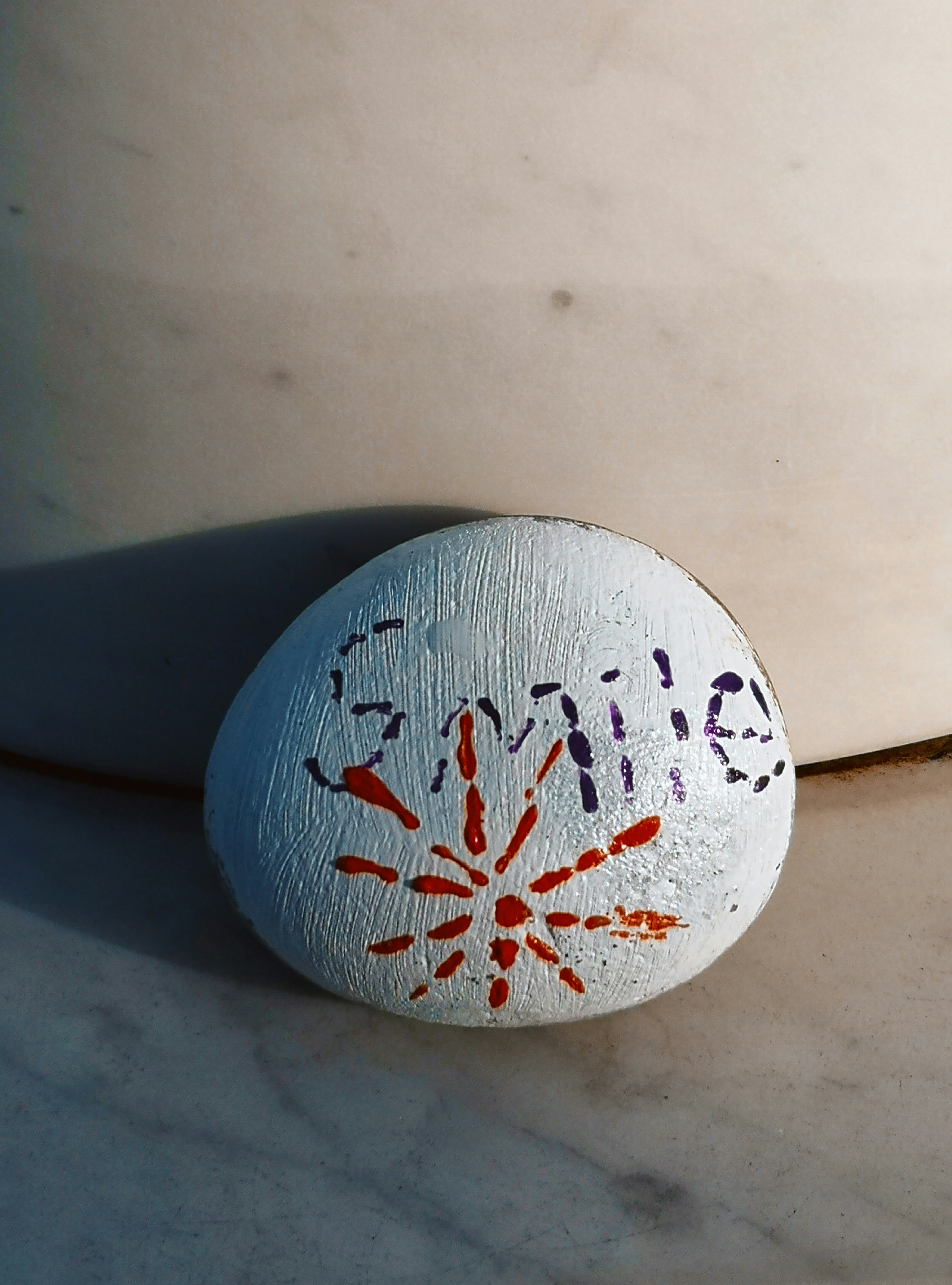 Painted Marble on Marble: A Tiny Burst of Color on a Quiet Surface