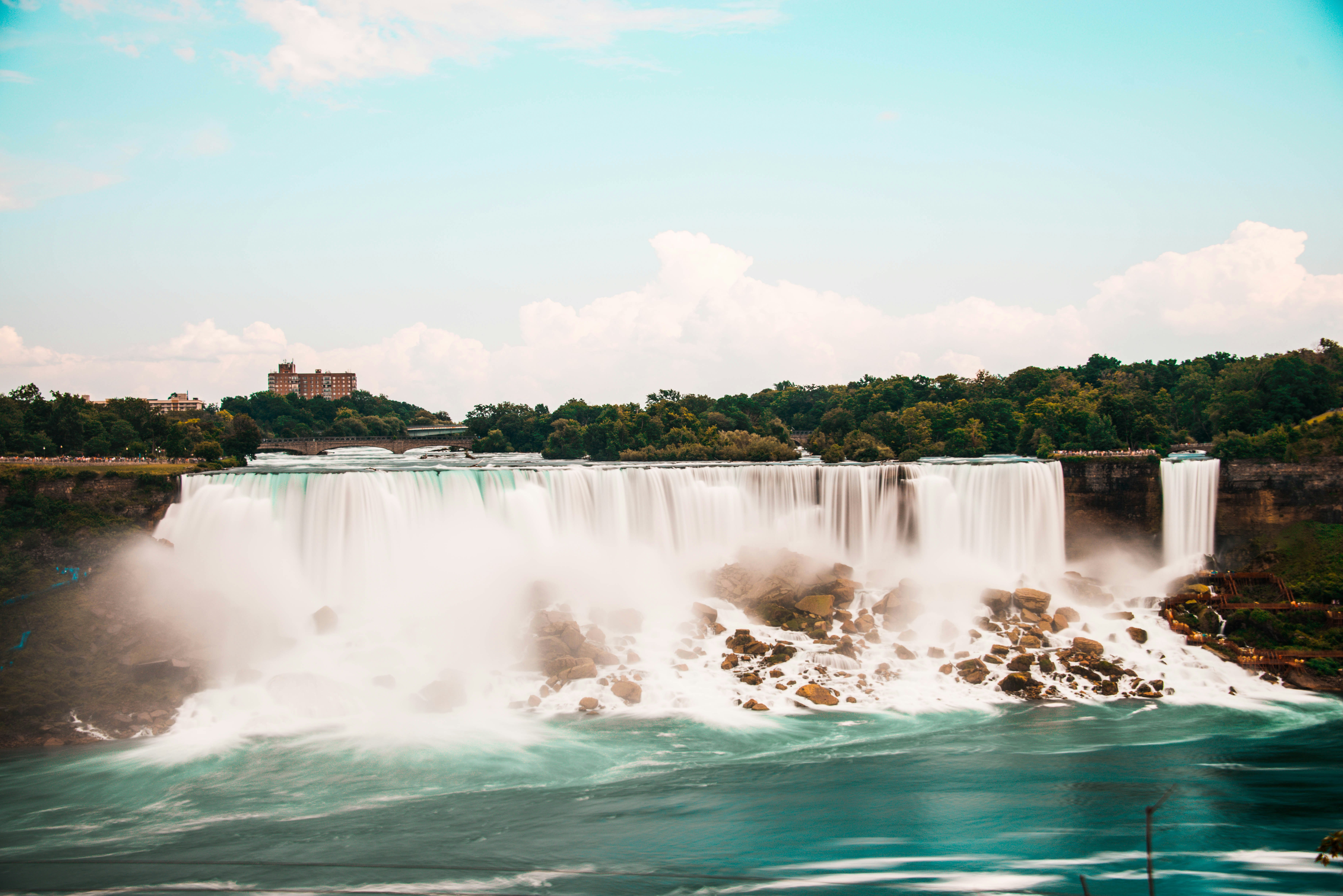 Azure Curtain of Water: A Silky Cascade Beneath a Calm Sky