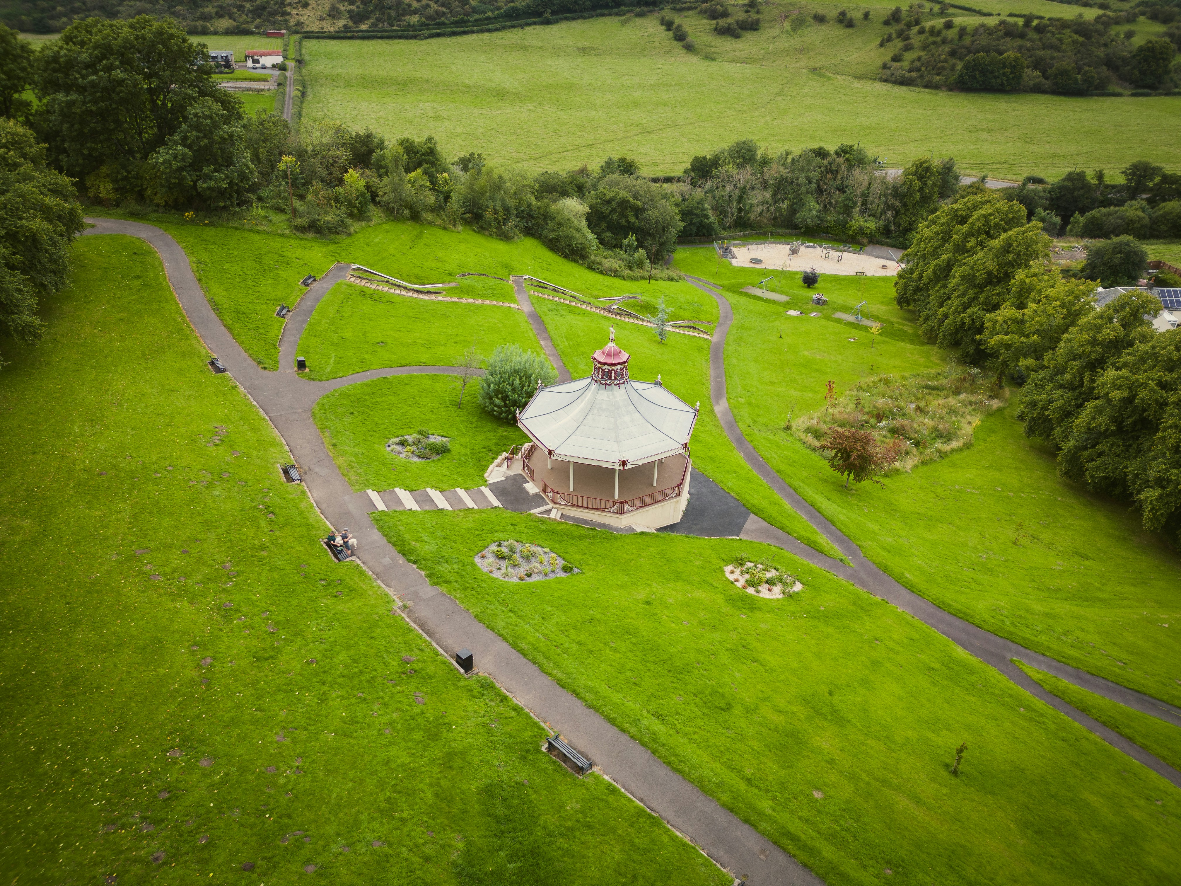 An aerial view of a building in a green field photo – Free Stonehouse ...