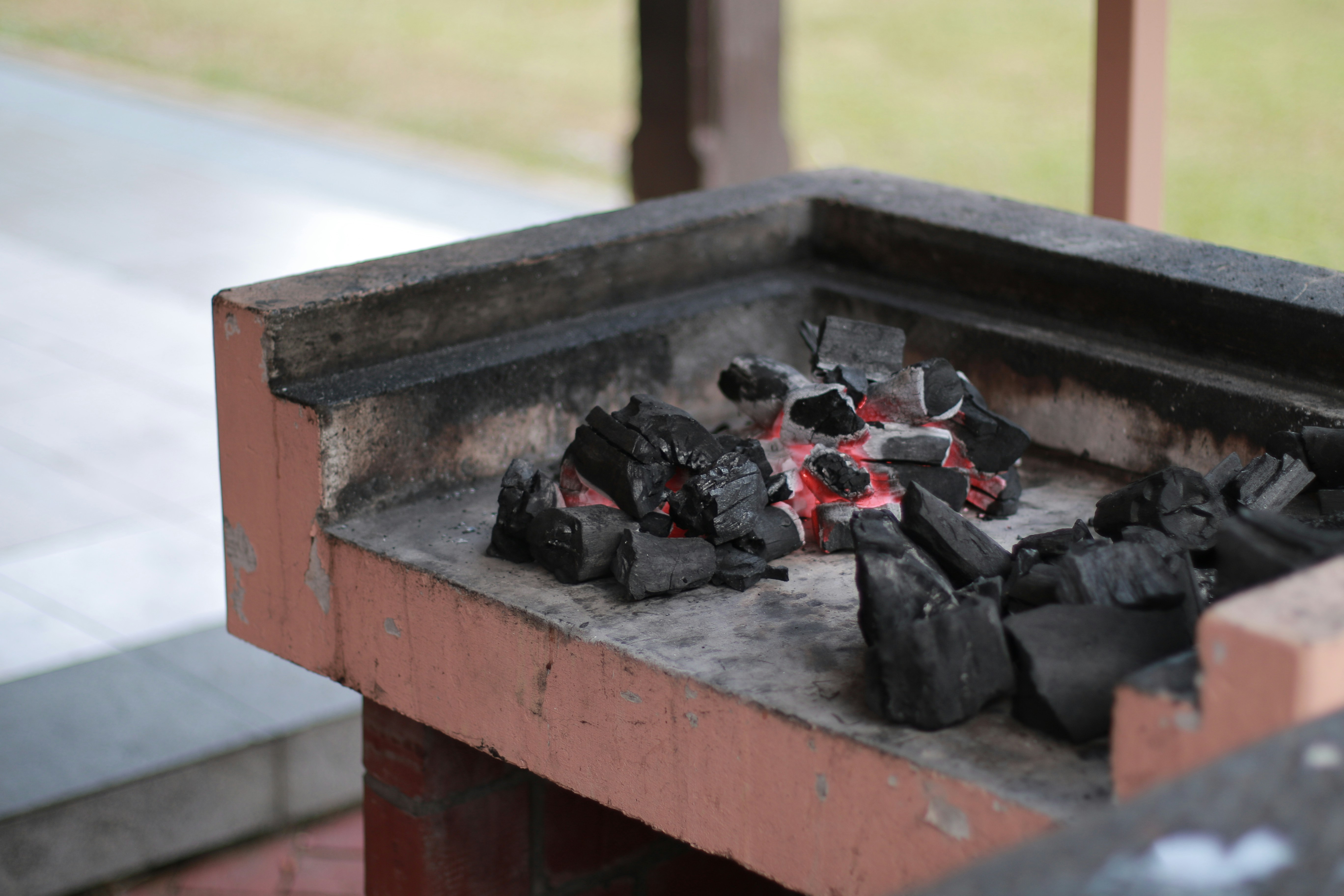 Crimson Embers Resting on a Weathered Brick Barbecue