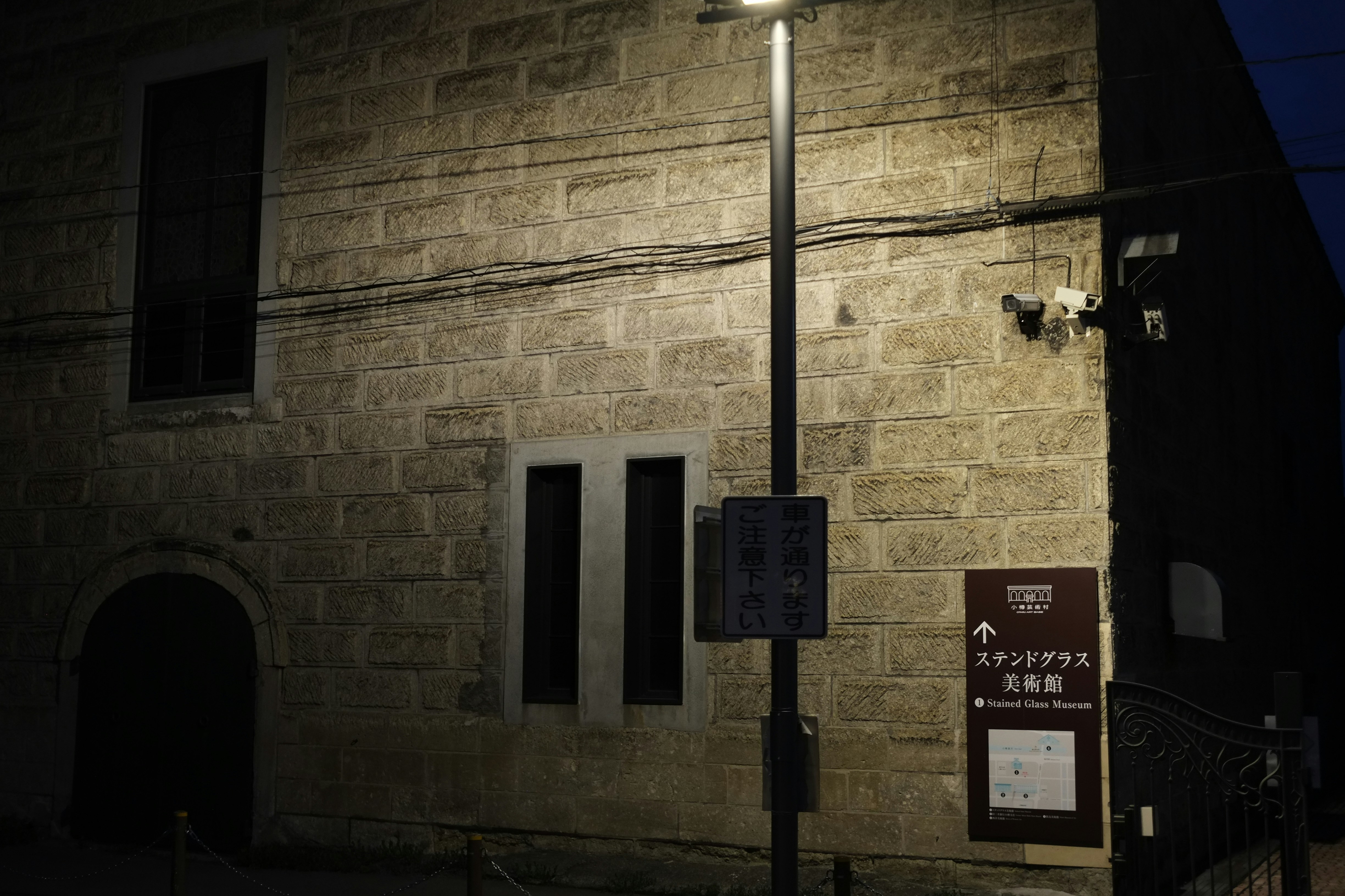 Nightfall on a Historic Stone Facade Beneath a Lone Streetlamp