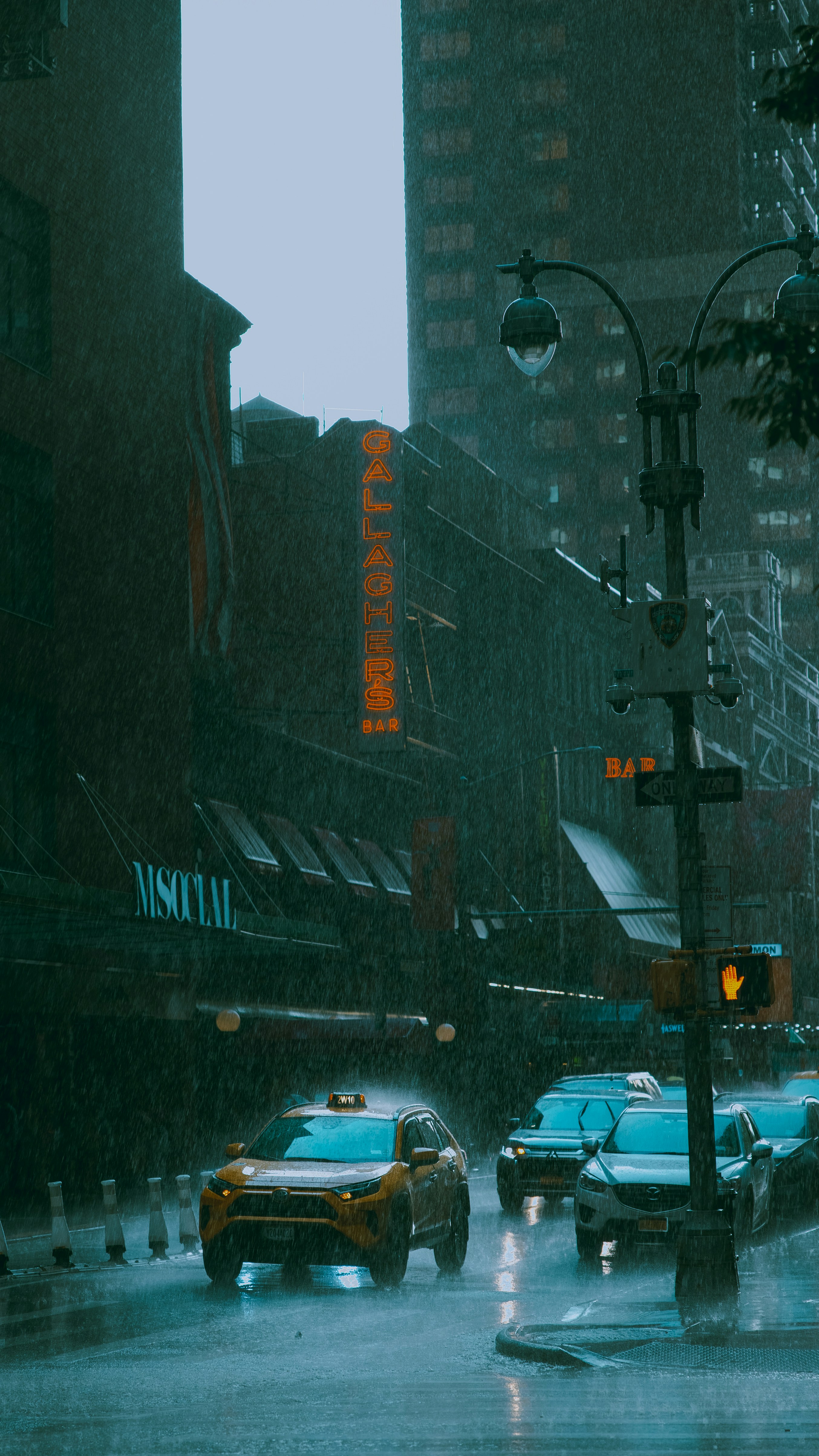 Neon Sign and Rain on a City Street