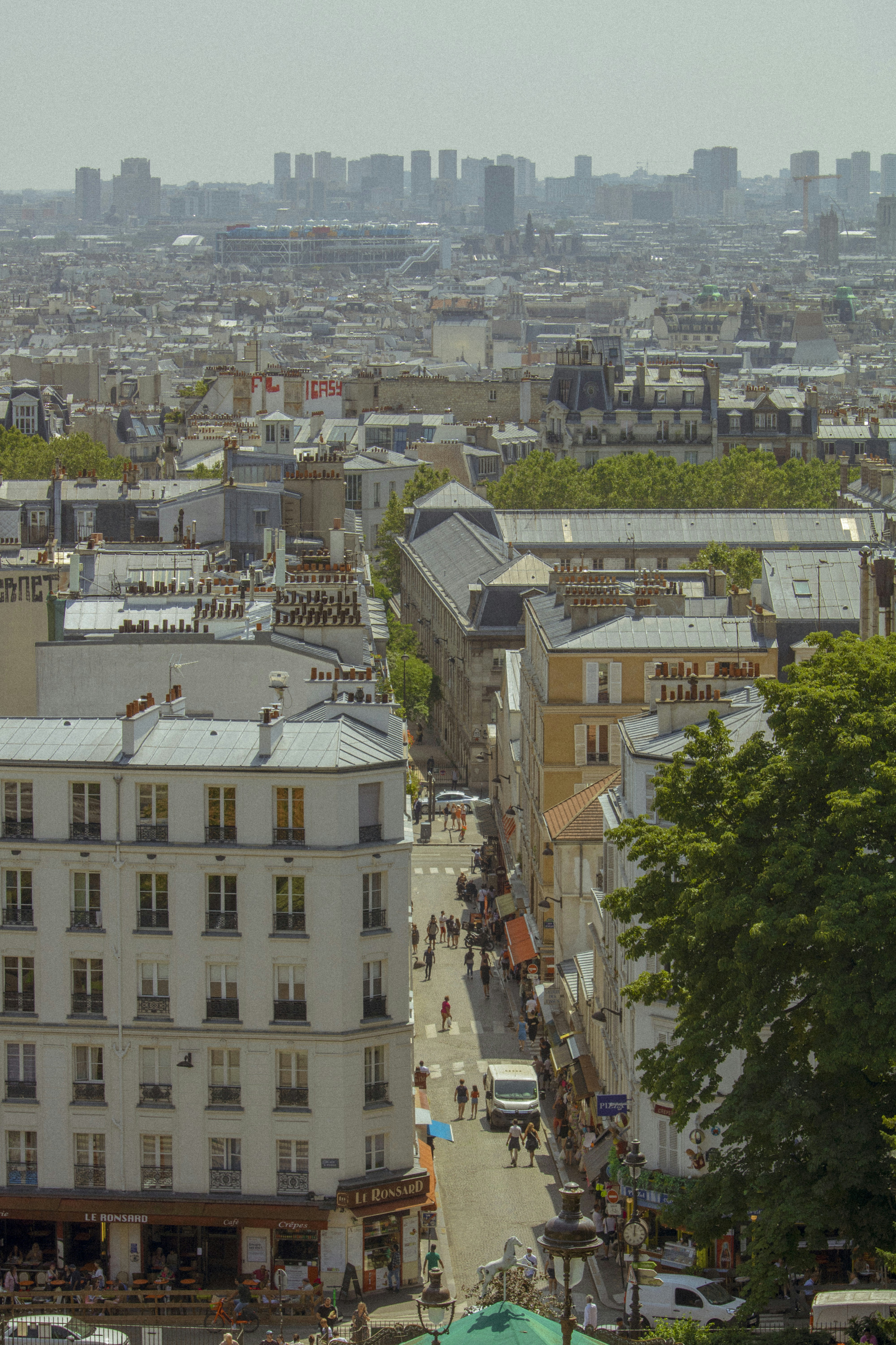 Parisian Avenue: Sunlit Street Life Among Convertibles and Café Terraces