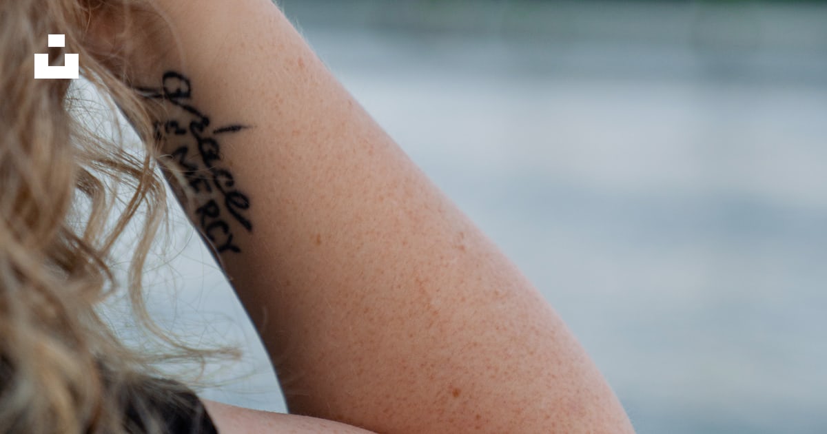 A Woman With A Tattoo On Her Arm Photo Free Orlando Image On Unsplash