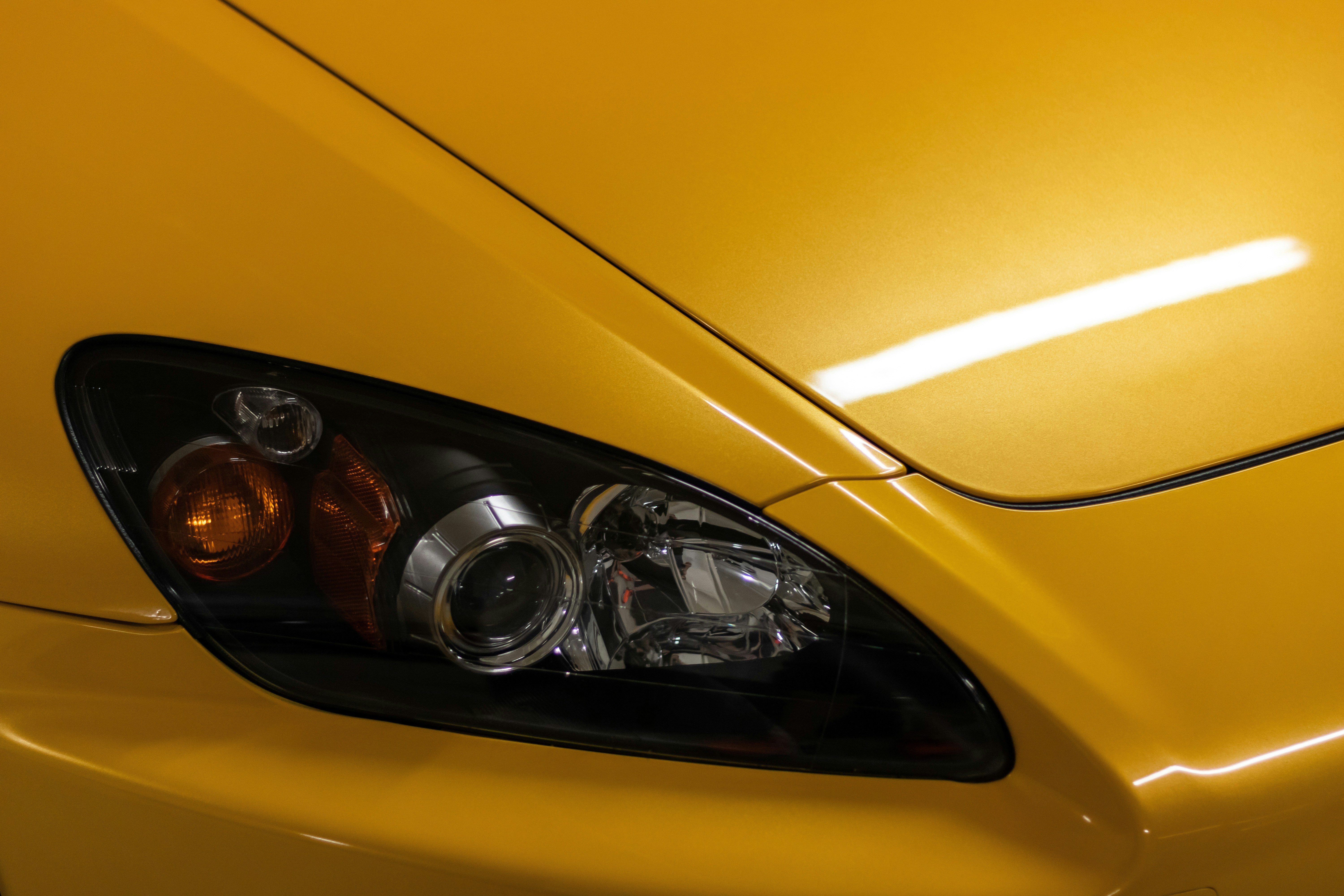 A close up of a yellow sports car headlight photo – Free Headlight ...