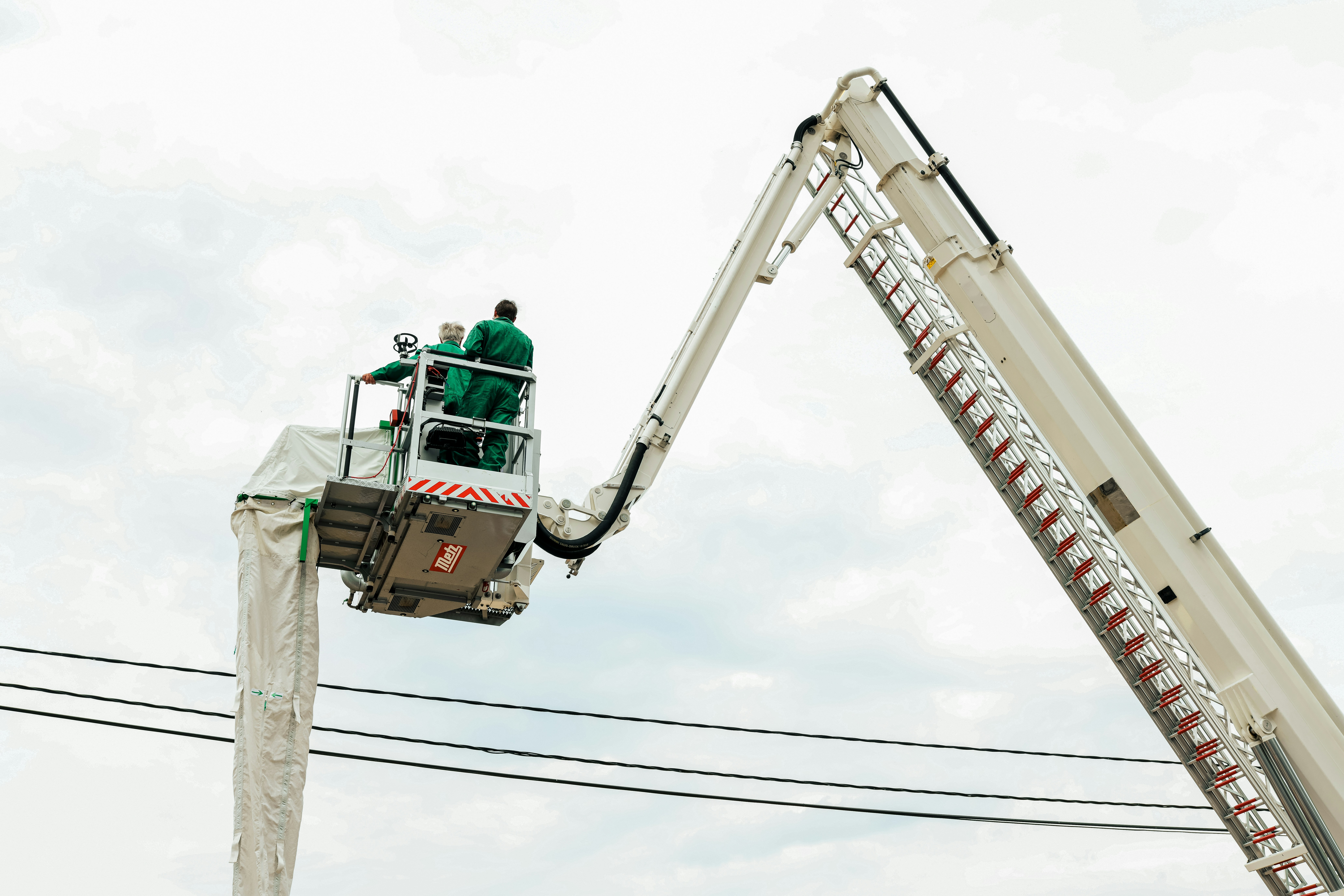 A man on a cherry picker working on power lines photo – Free ...