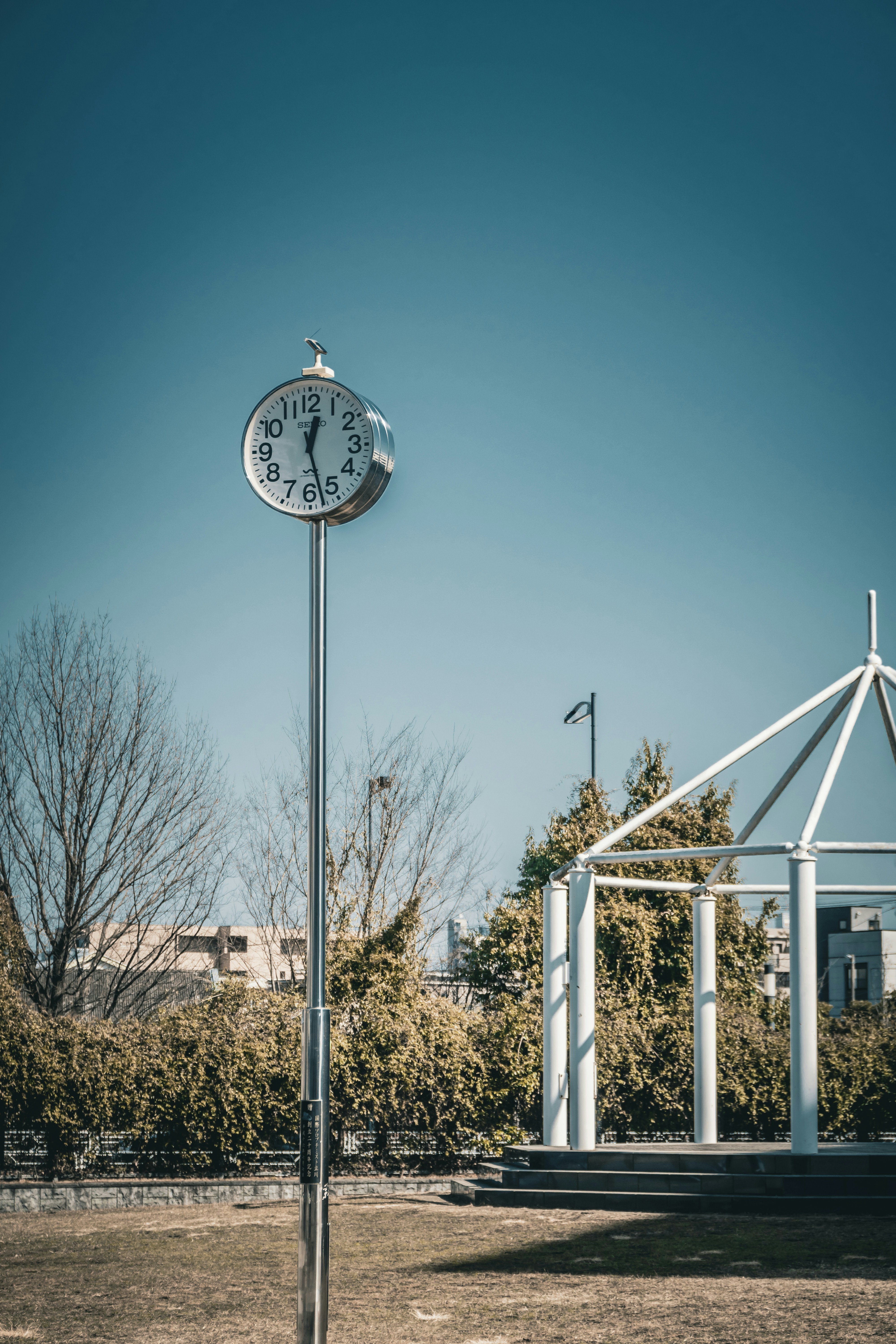 Midday Sentinel: A Lone Clock Against Cerulean Sky