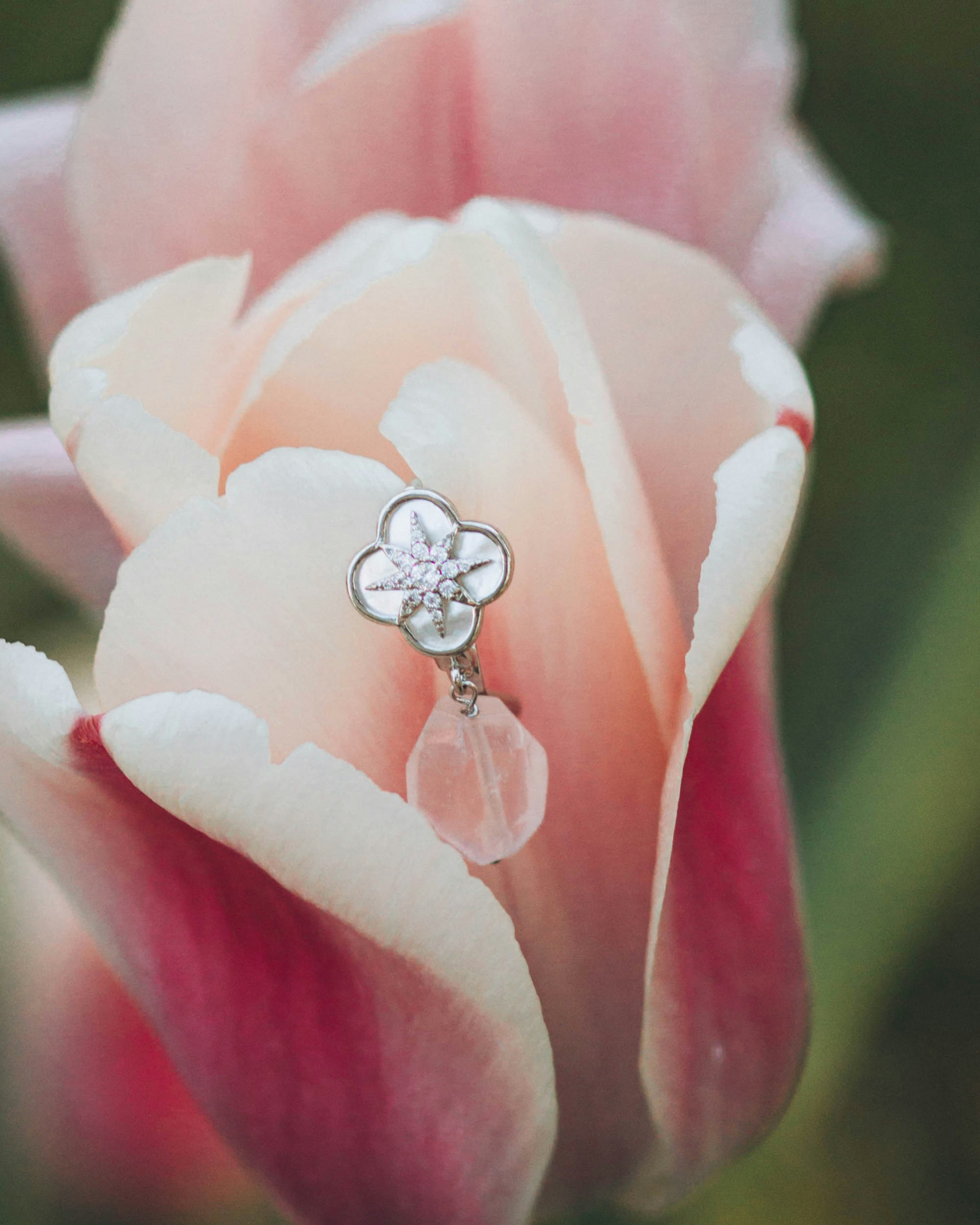 Blush Tulip Spotlight: A Silver Flower Pendant Adorning the Petals