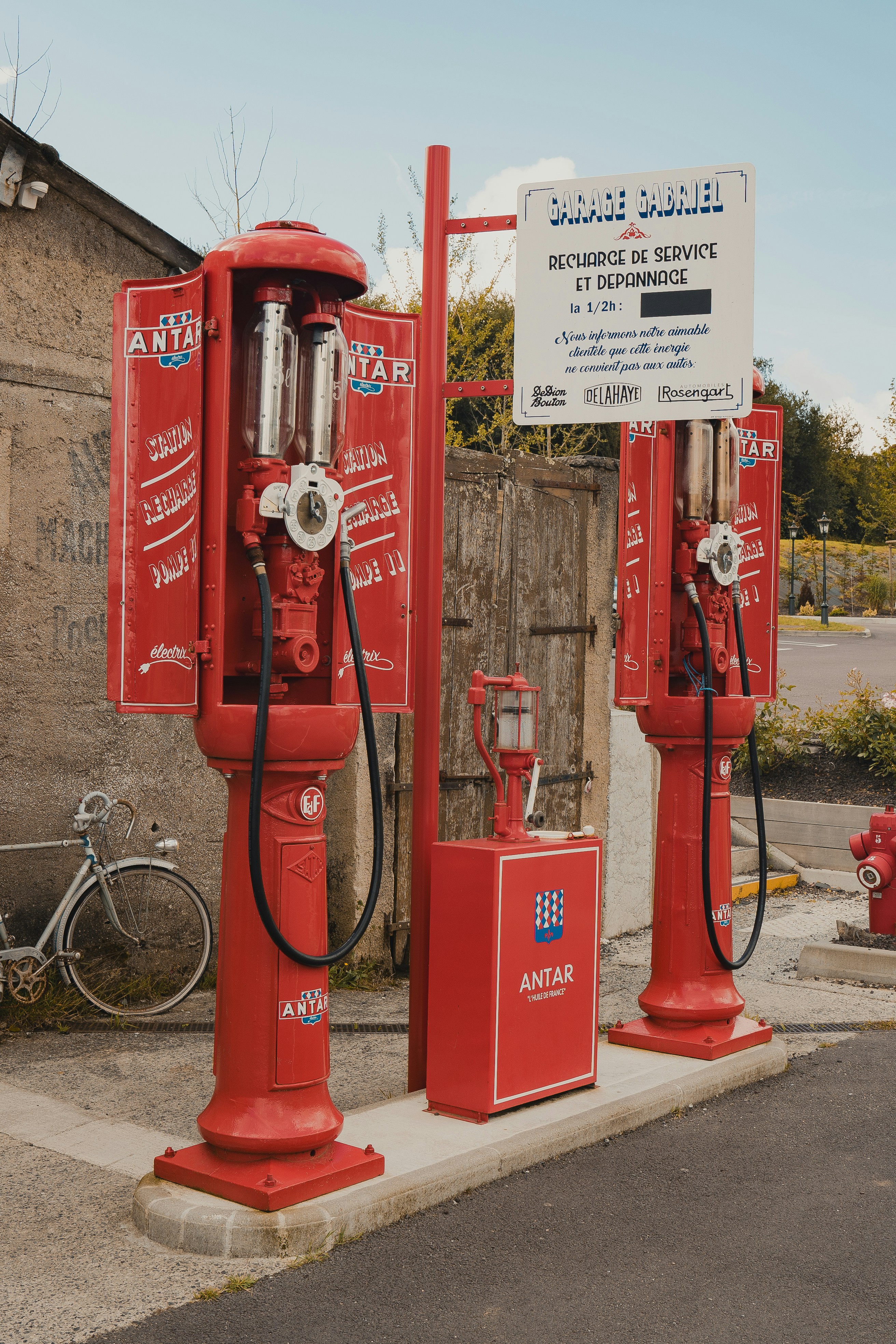 Two red gas pumps sitting next to each other photo – Free France Image ...