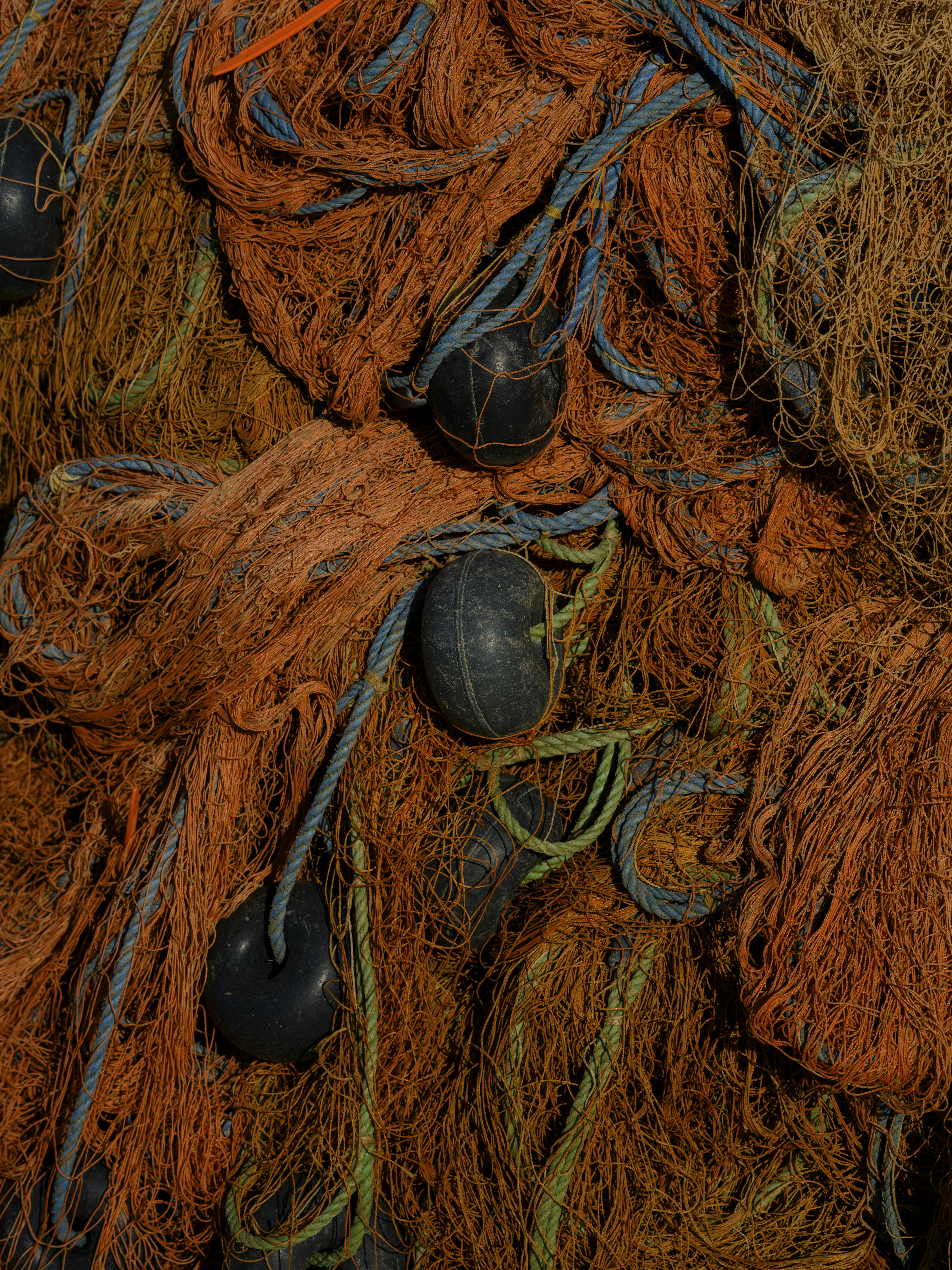 A pile of fishing nets with shoes on them photo – Free Rope Image on ...