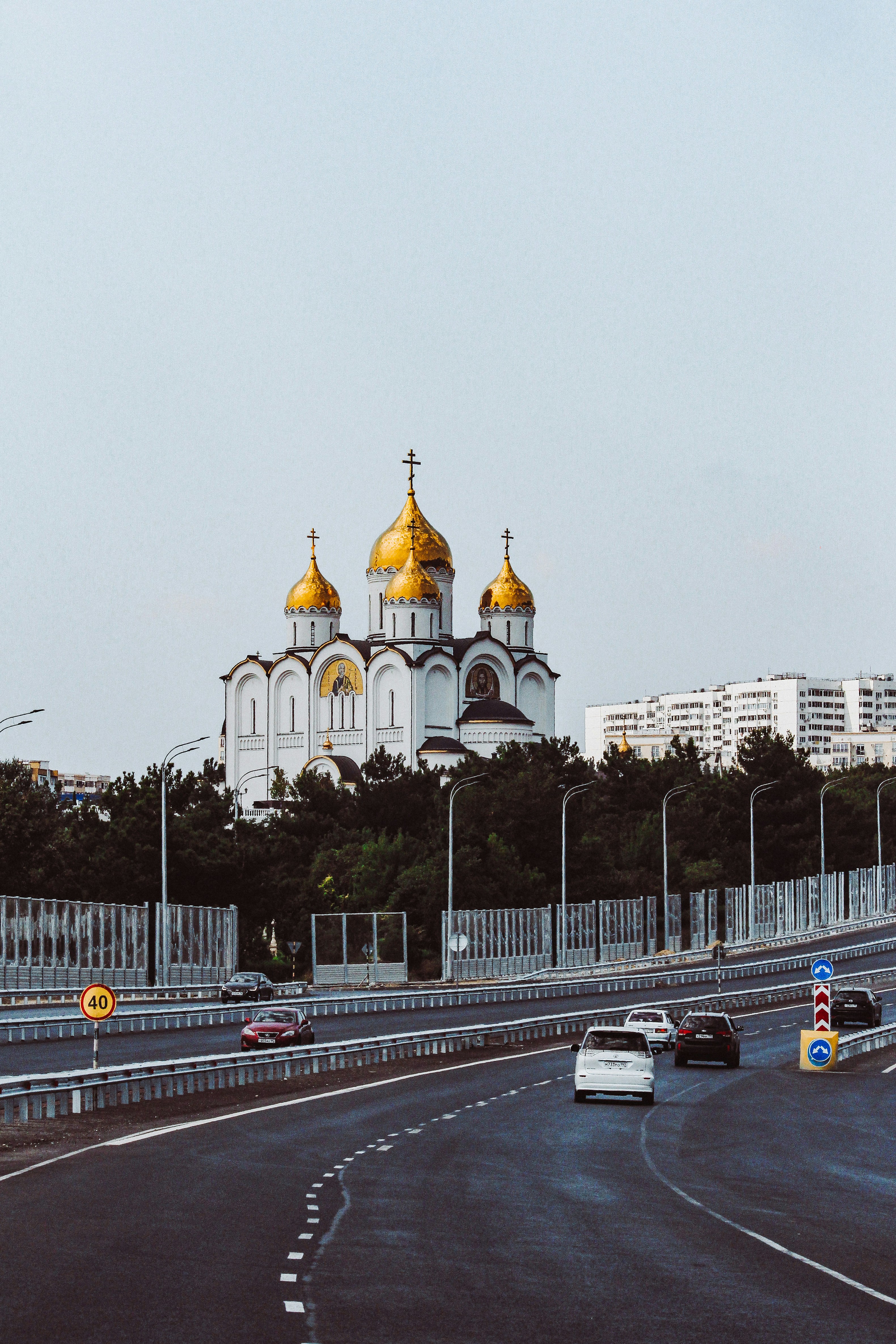 Golden-domed church rising above the overpass in a quiet city