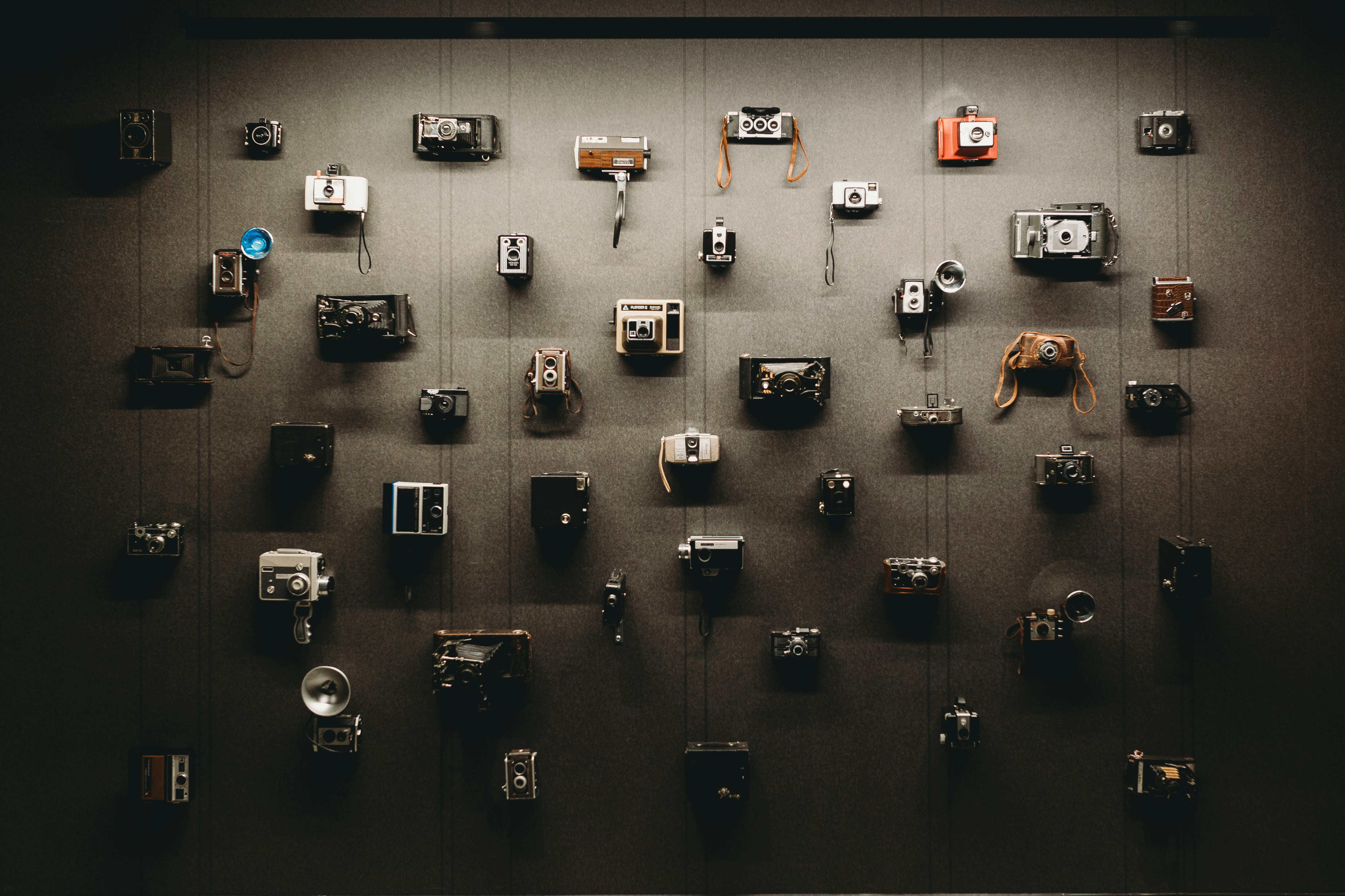 A wall with many different types of cameras on it photo – Free ...