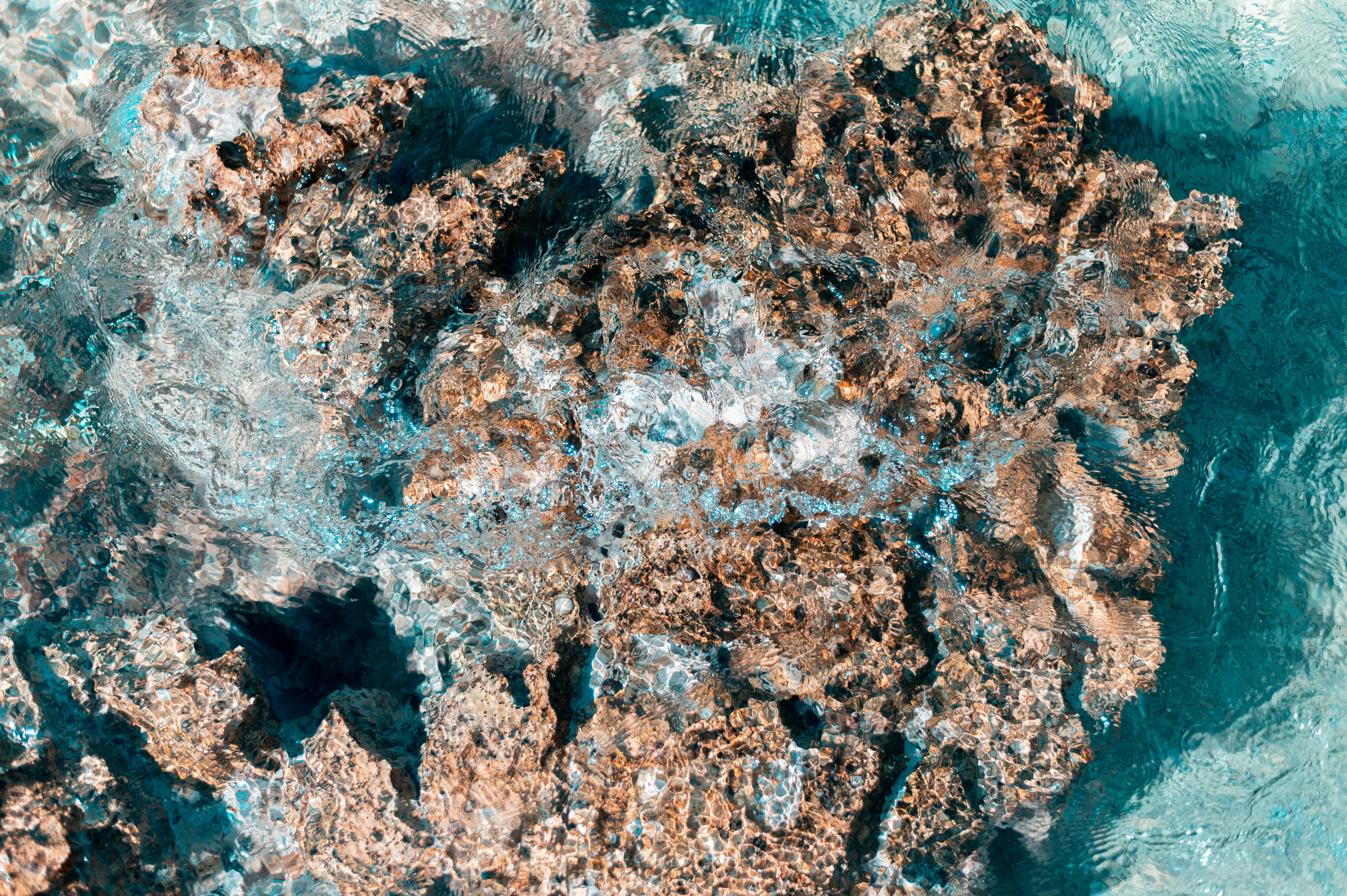 Coastal Coral Fortress: Aerial View of Rugged Rocky Islet Eroded by Turquoise Seas
