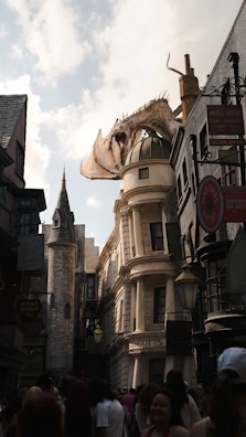 A bustling street scene featuring a large, detailed dragon perched atop ...