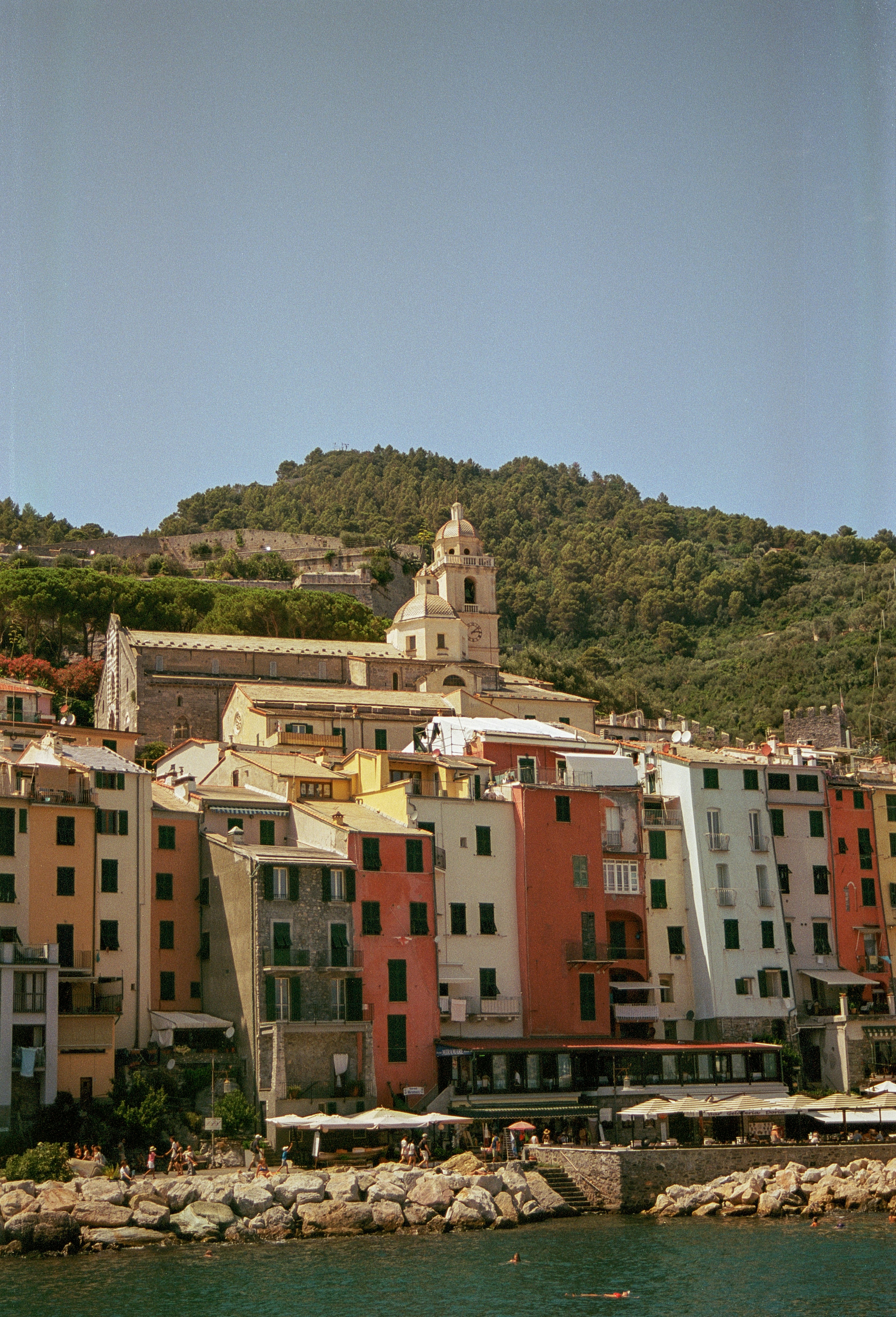Colorful Mediterranean Coastline: Sea, Rocks, and Palette-Painted Houses