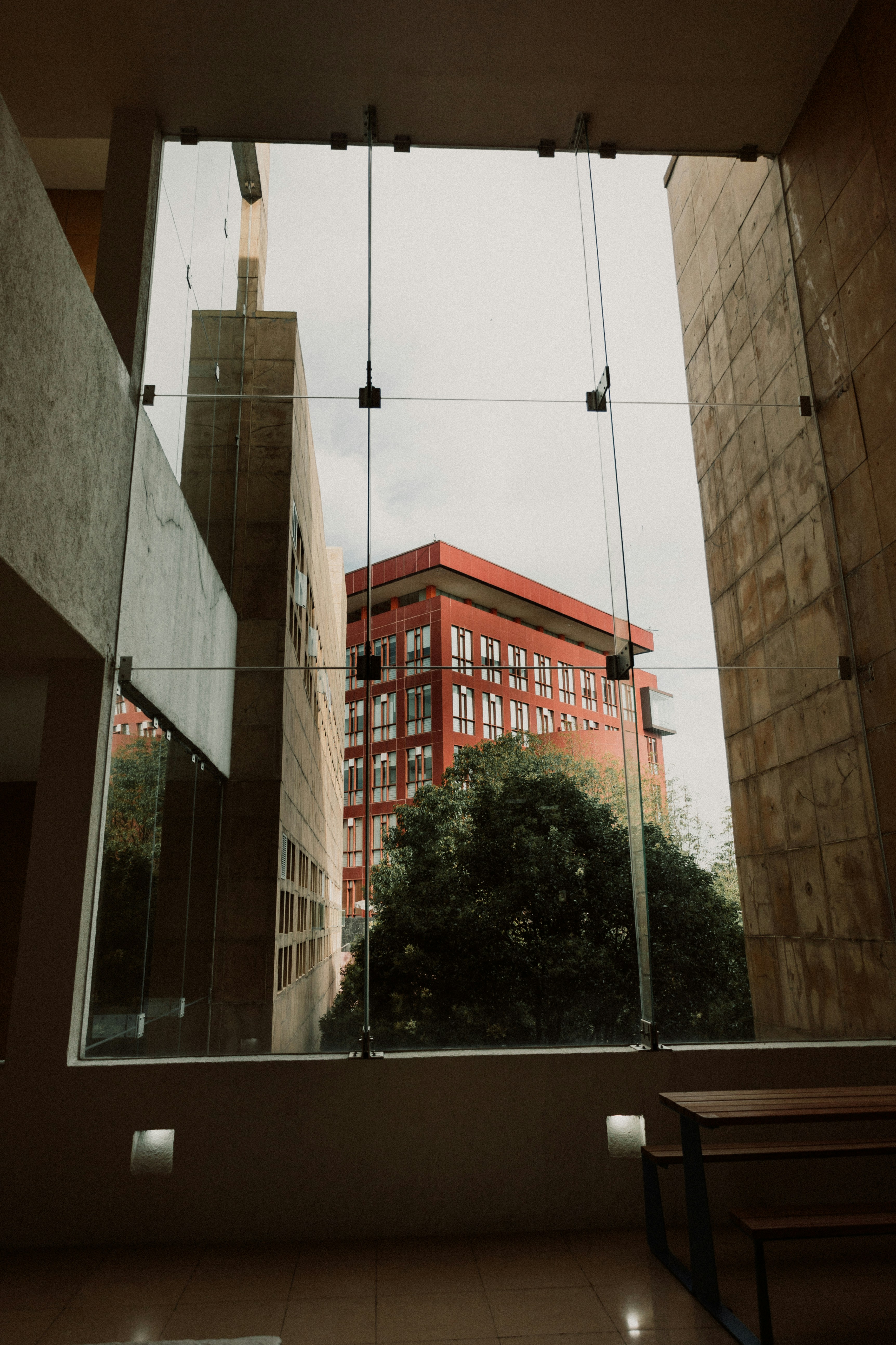 A view of a building through a glass window photo – Free Building Image ...
