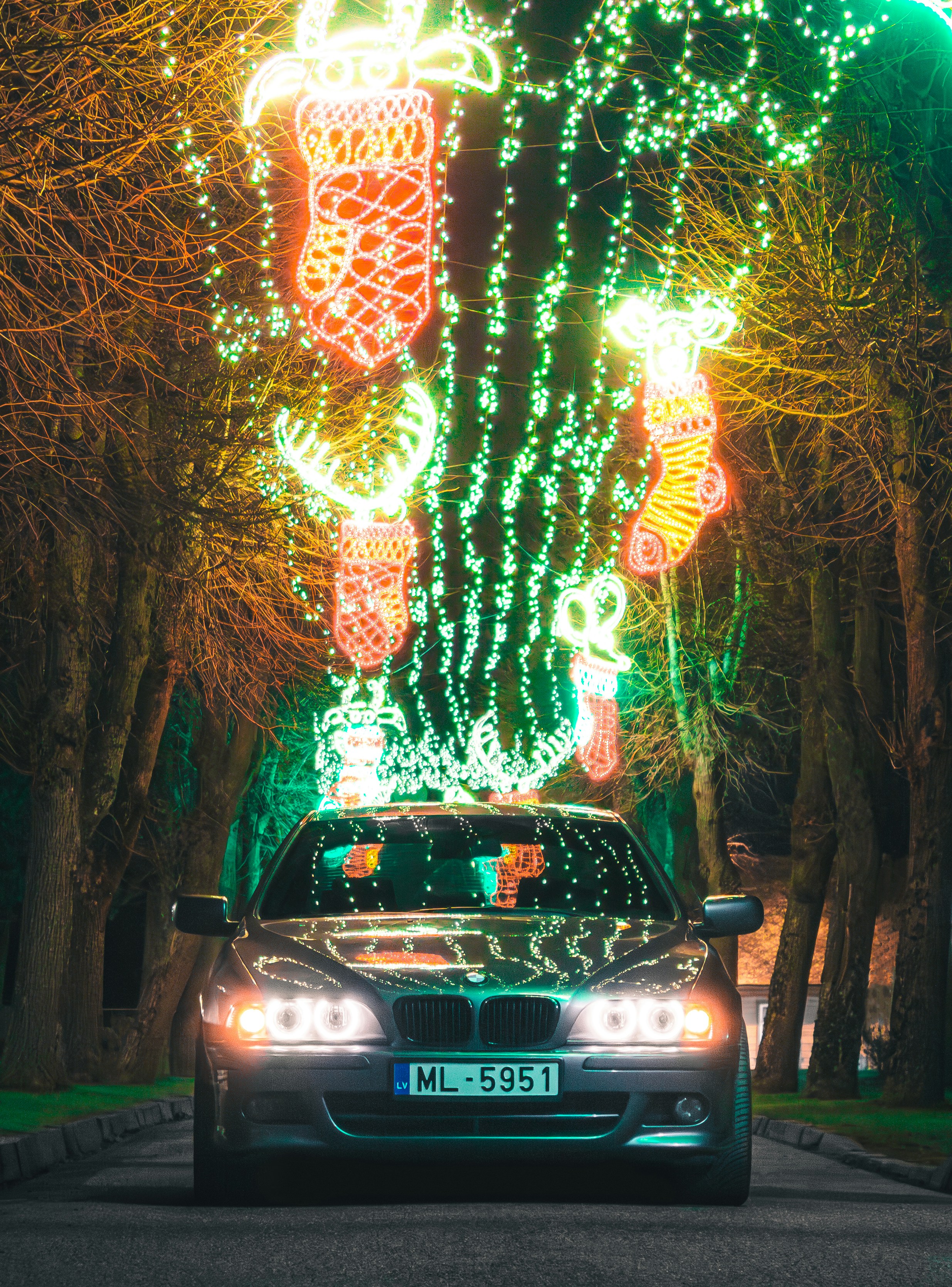 Neon Night Drive Beneath a Canopy of Holiday Lights