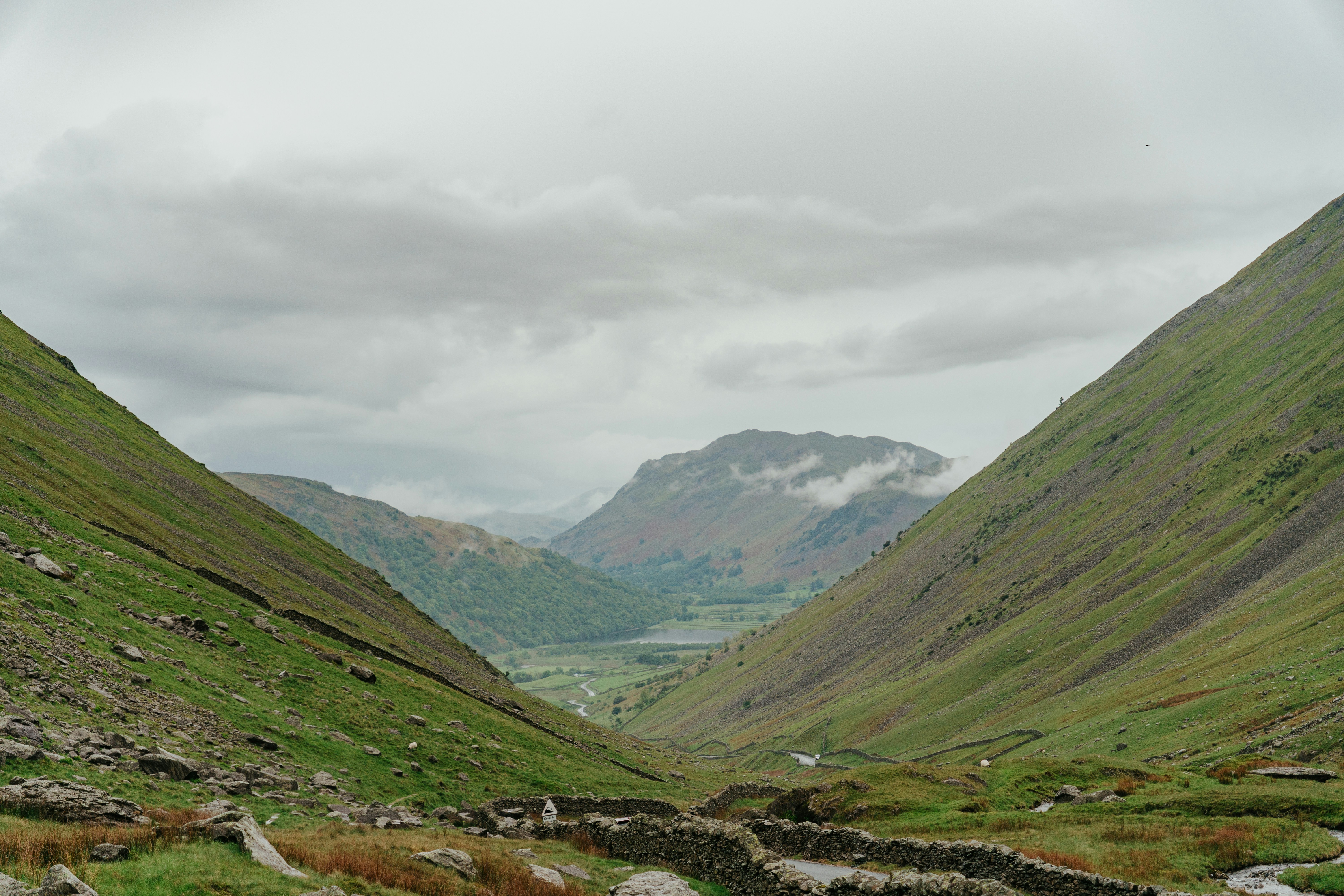 A view of a valley with mountains in the background photo – Free ...
