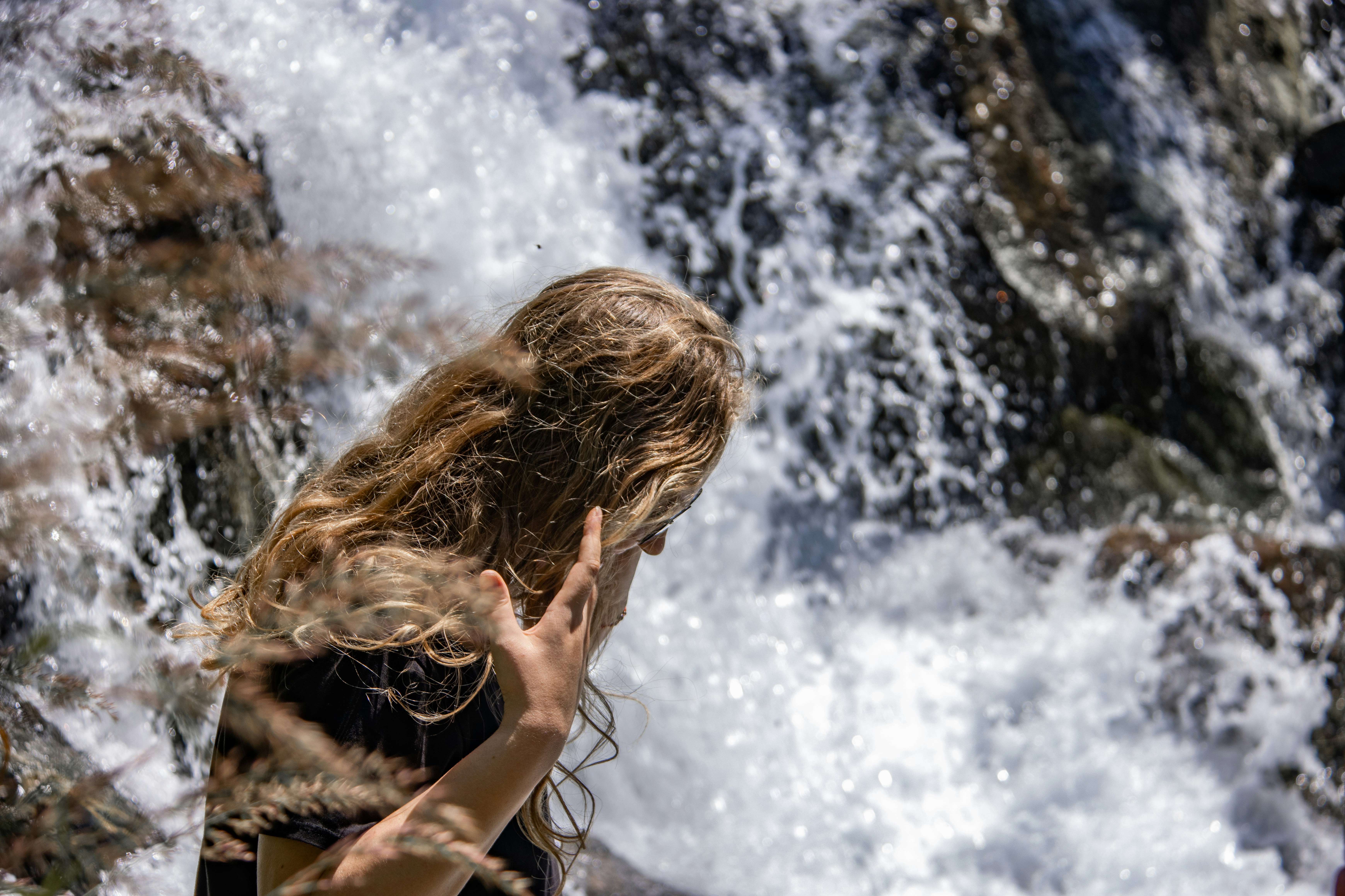 A woman standing in front of a waterfall photo – Free Chuchkhur ...