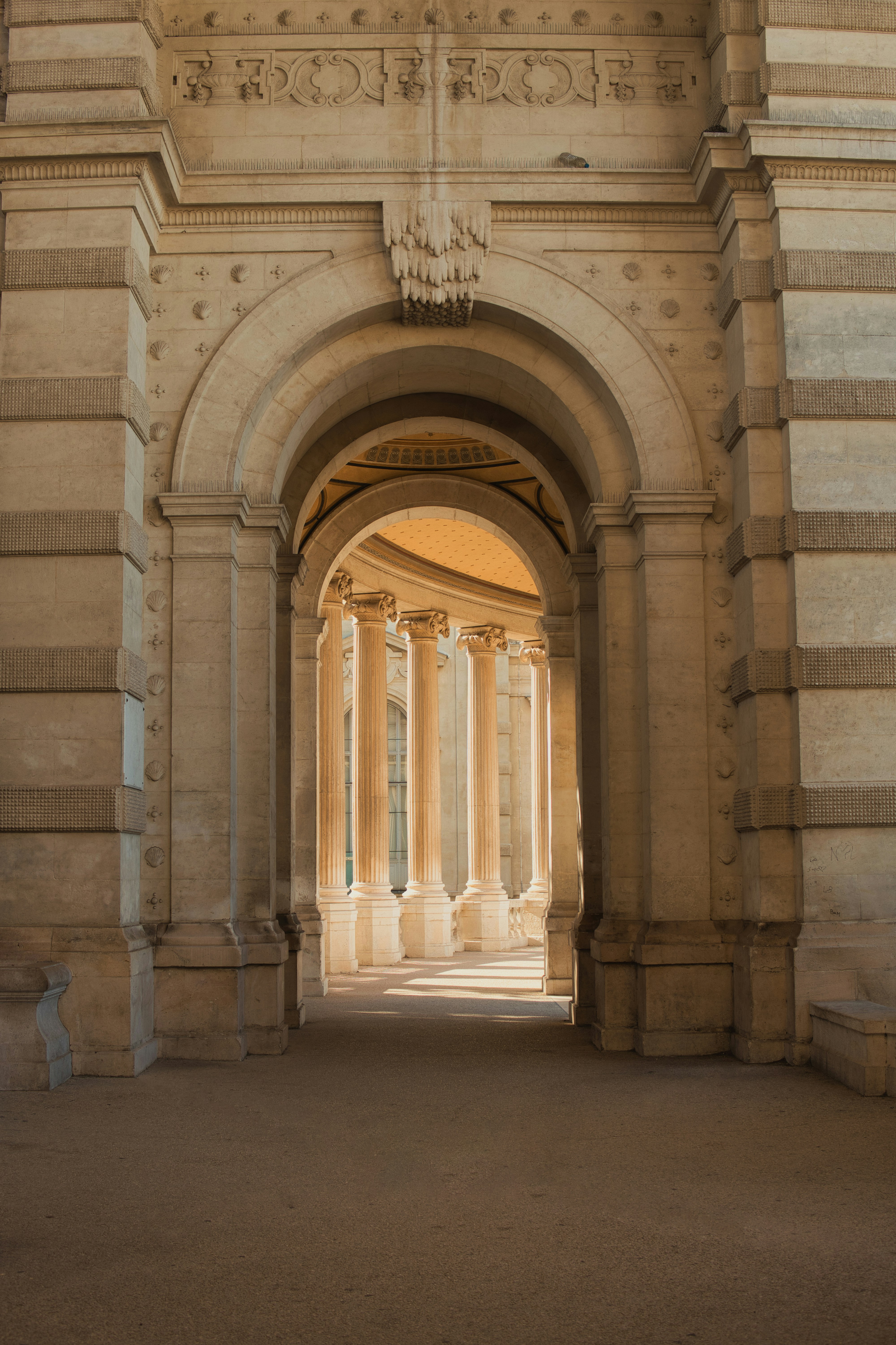 An archway leading into a building with columns photo – Free Palais ...