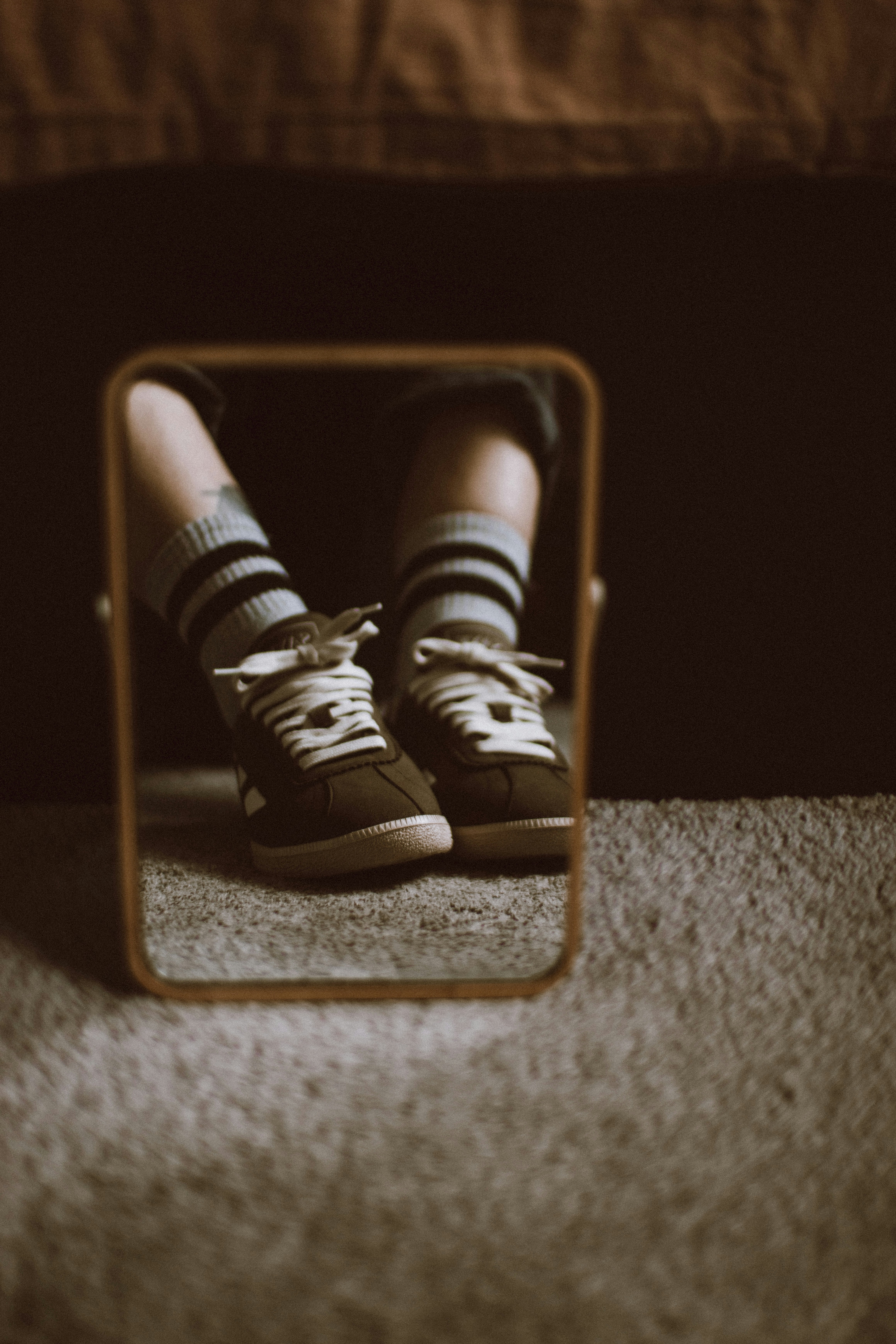 A person's reflection in a mirror on the floor photo – Free Shoe Image ...