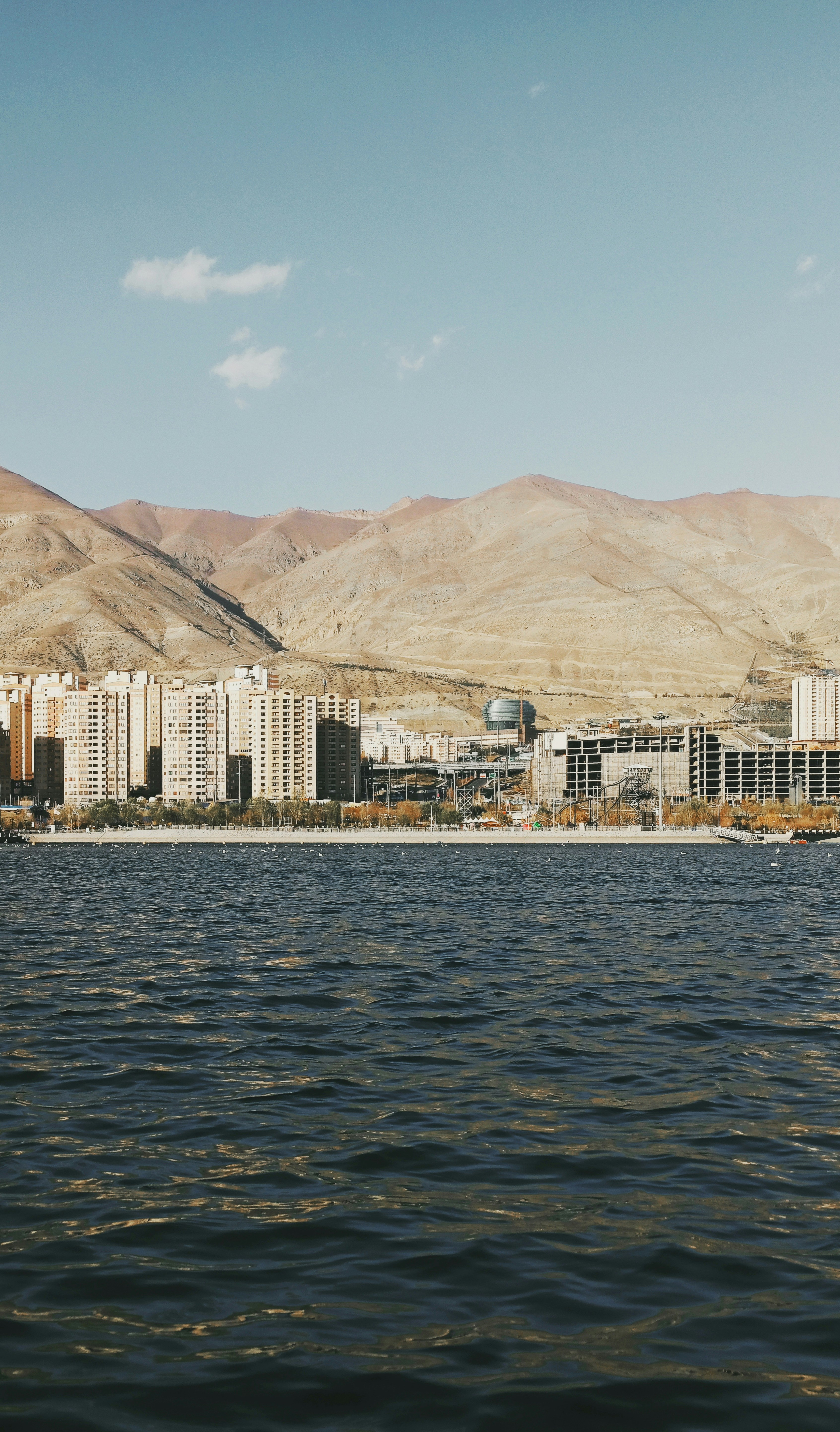 Desert Horizon Meets Waterfront: Cityscape Along a Calm Harbor