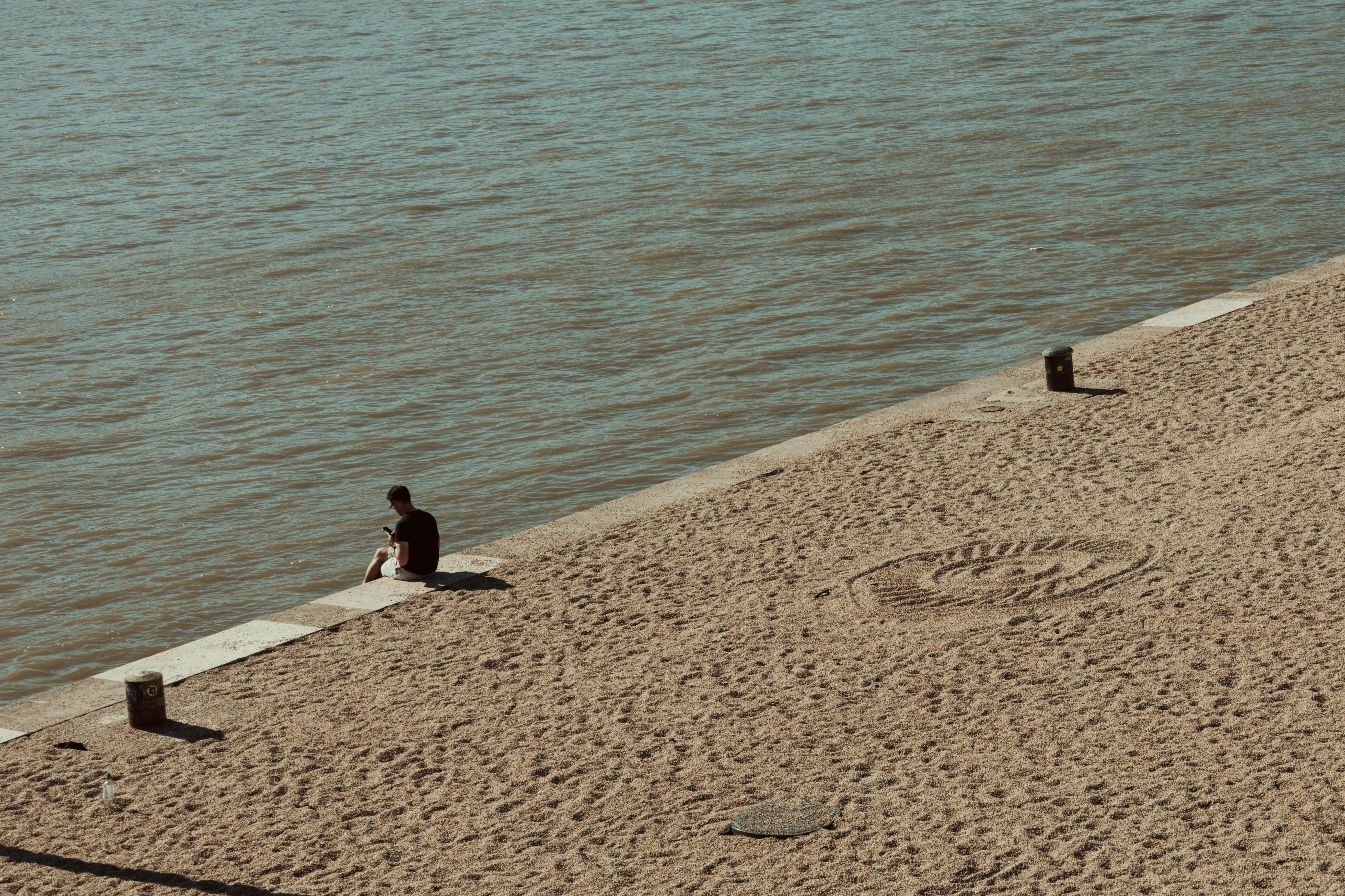 Solitary Moment Along the Beachside Concrete Walk
