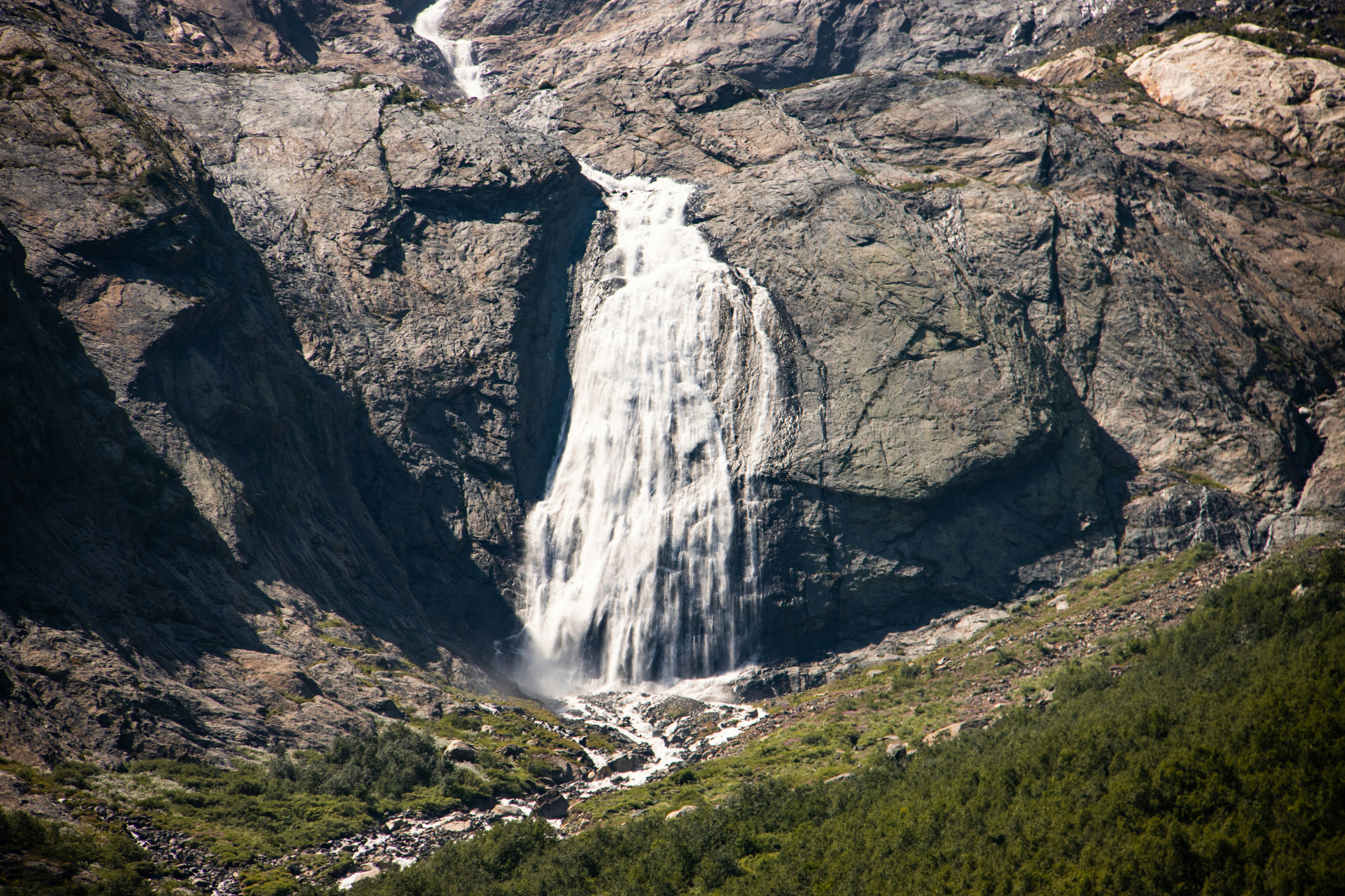 A very tall waterfall in the middle of a mountain photo – Free Caucasus ...