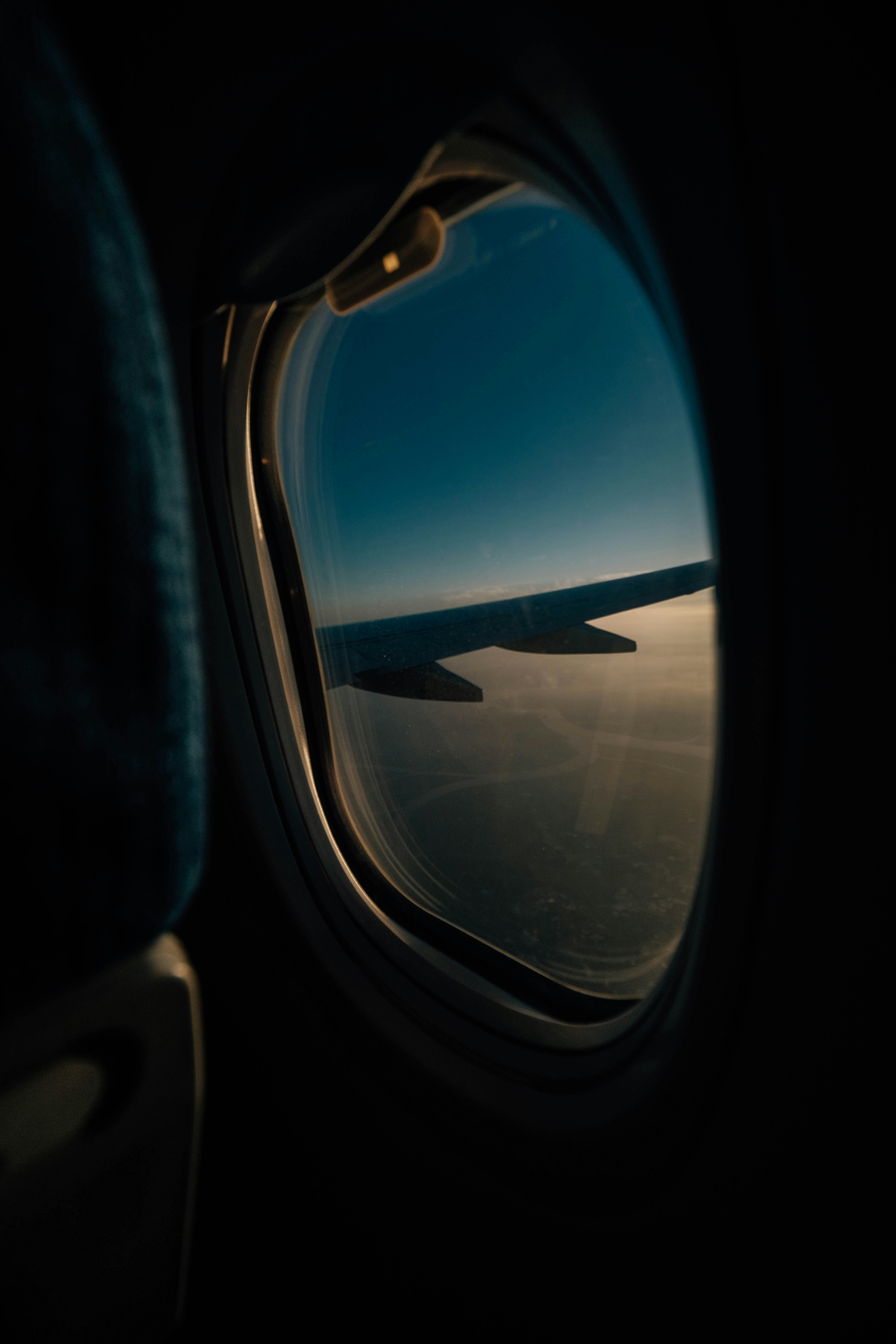 A view of the wing of an airplane through a window photo – Free Window ...