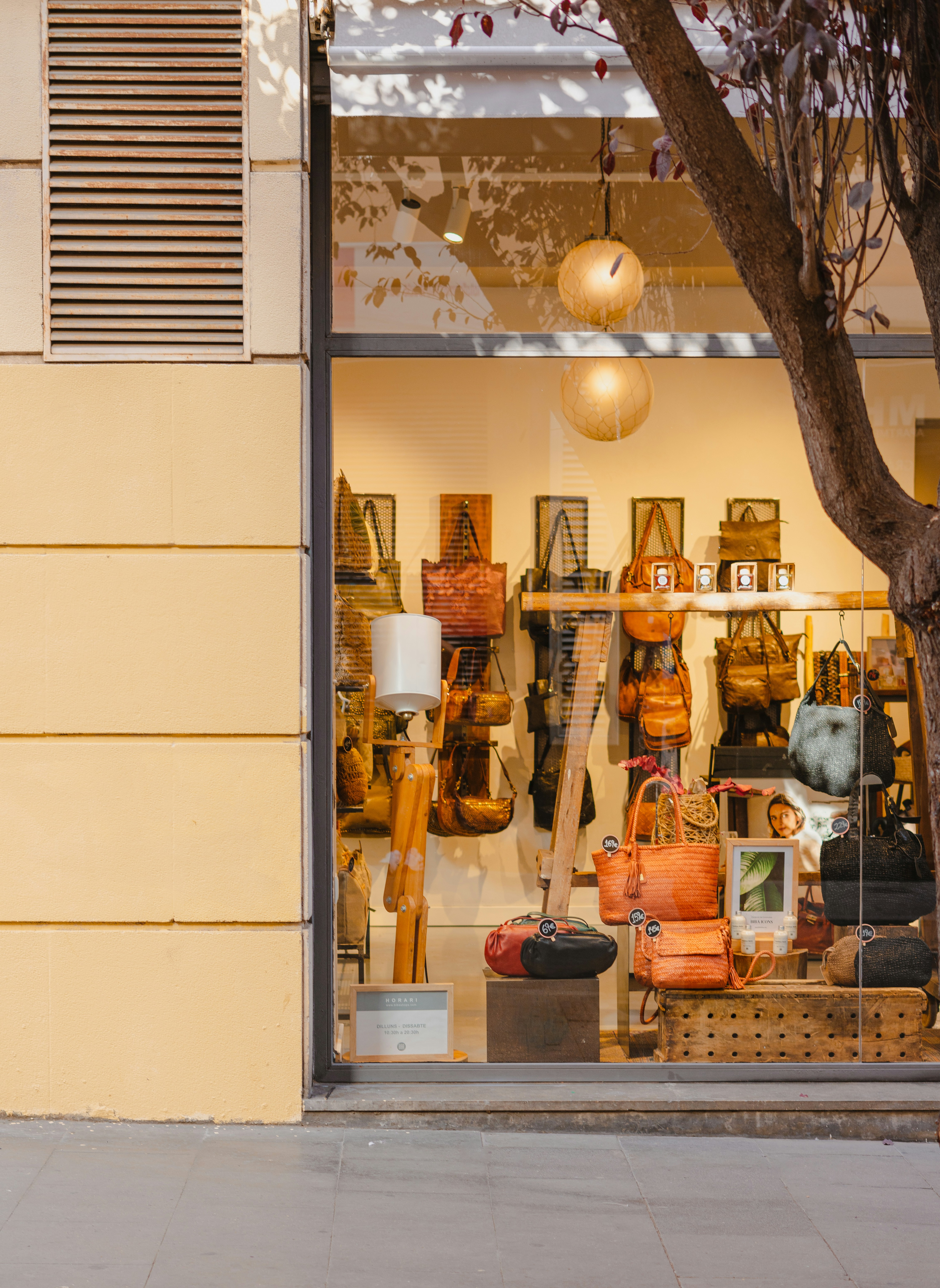 A store front with a display of handbags in the window photo – Free ...
