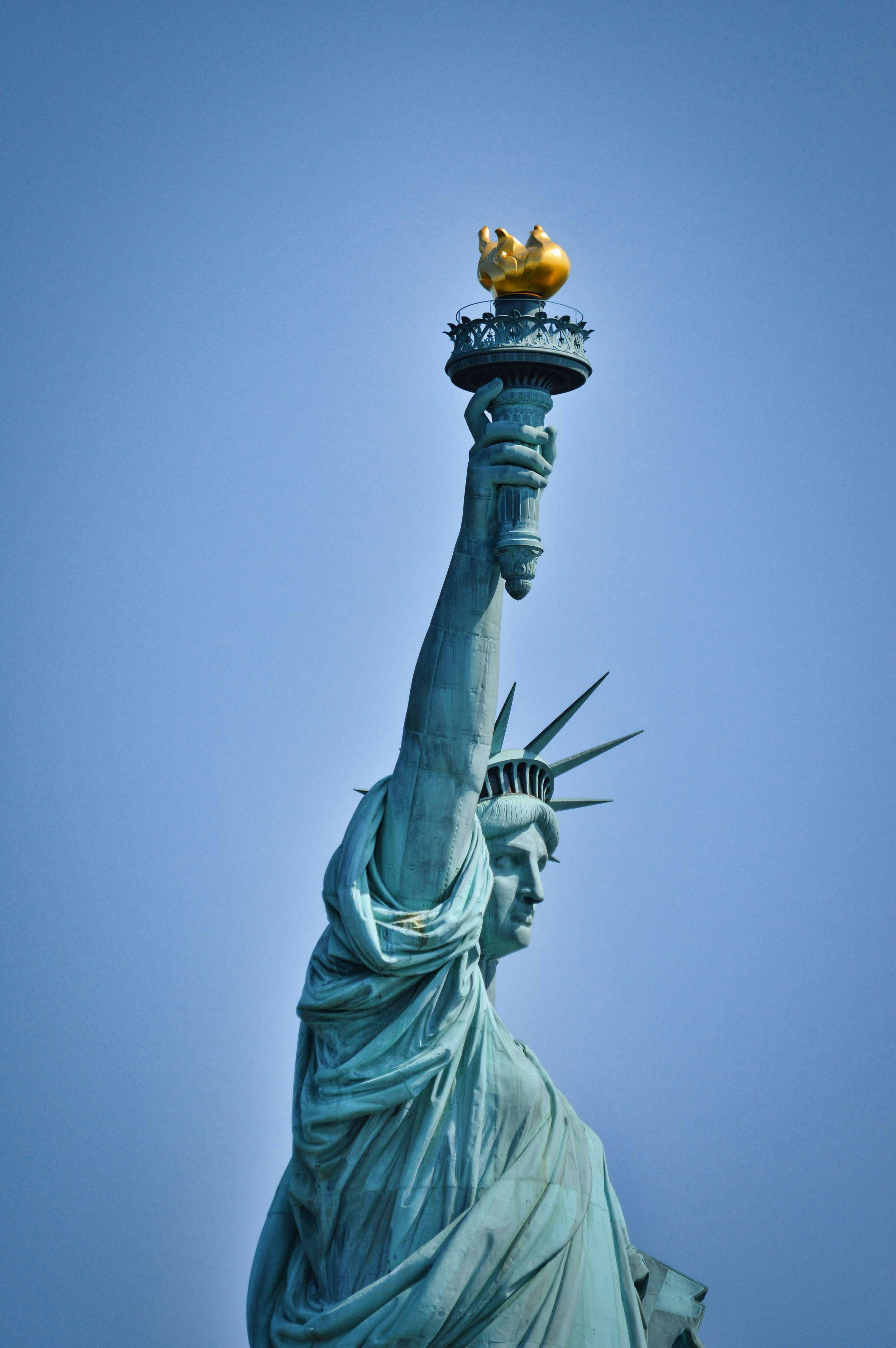 A gleaming torch atop liberty’s head: the statue’s crown reaches the sky