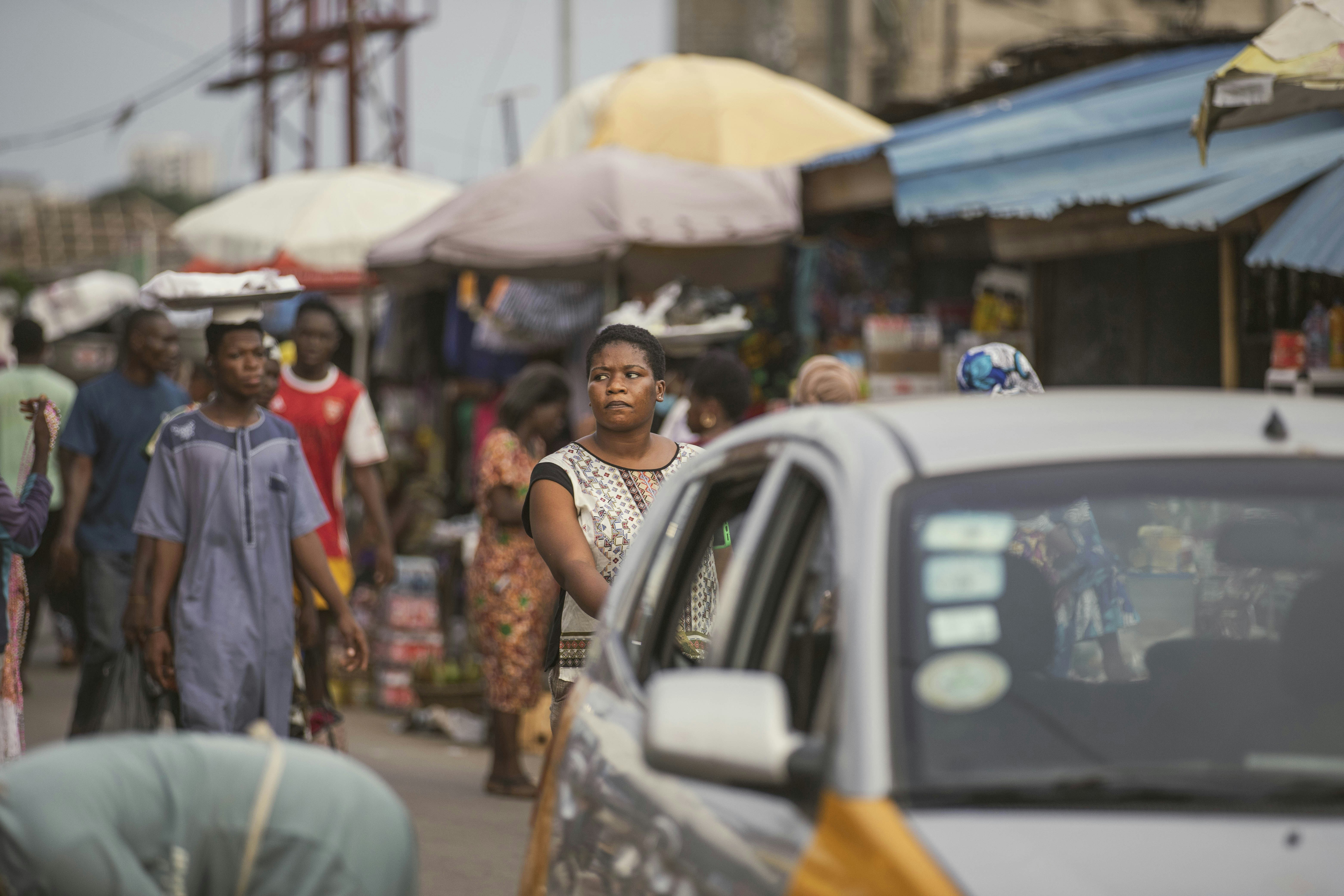 A group of people walking down a busy street photo – Free Street ...