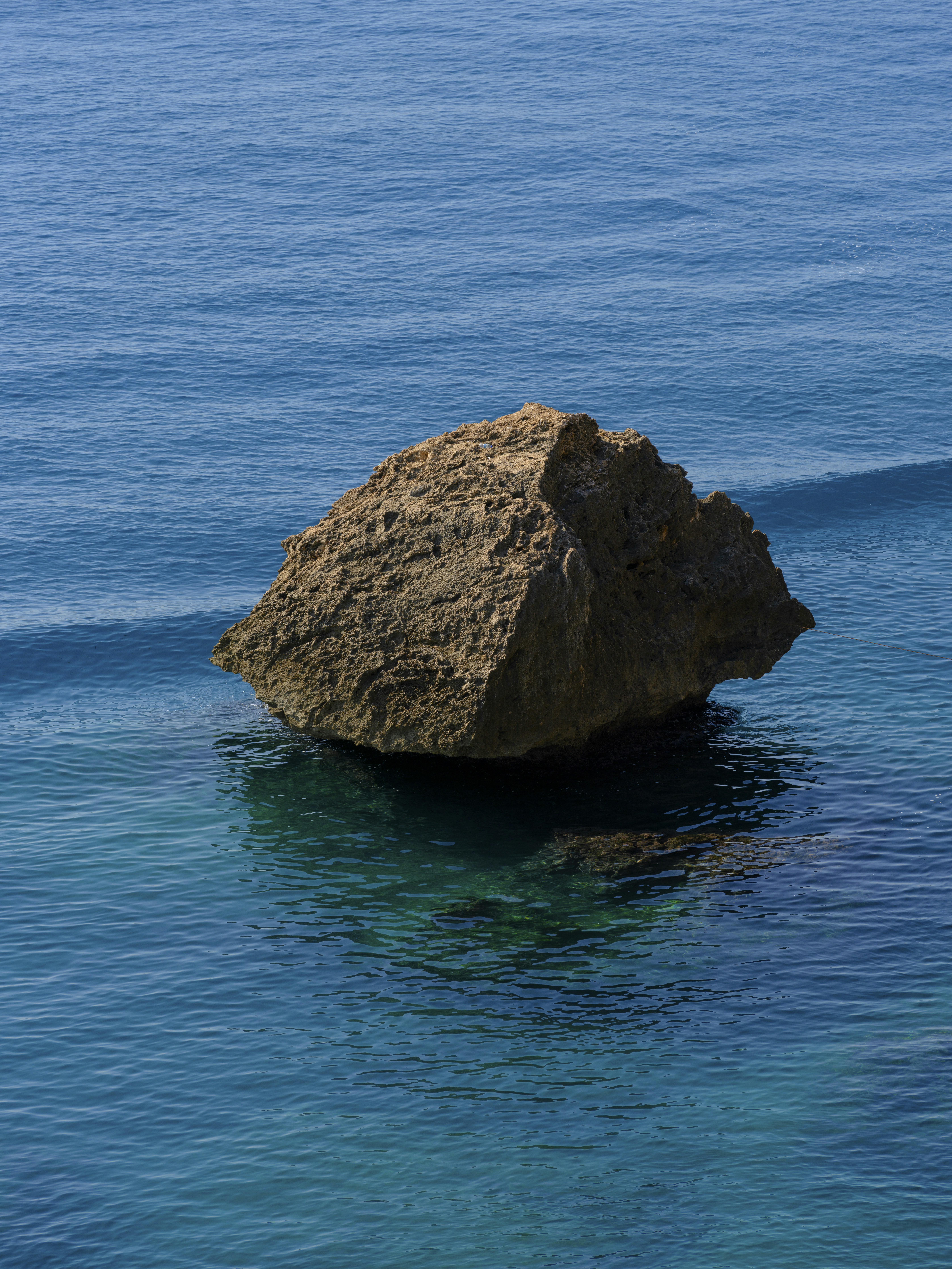 Solitary Sea Rock: A Quiet Sentinel in Turquoise Waters