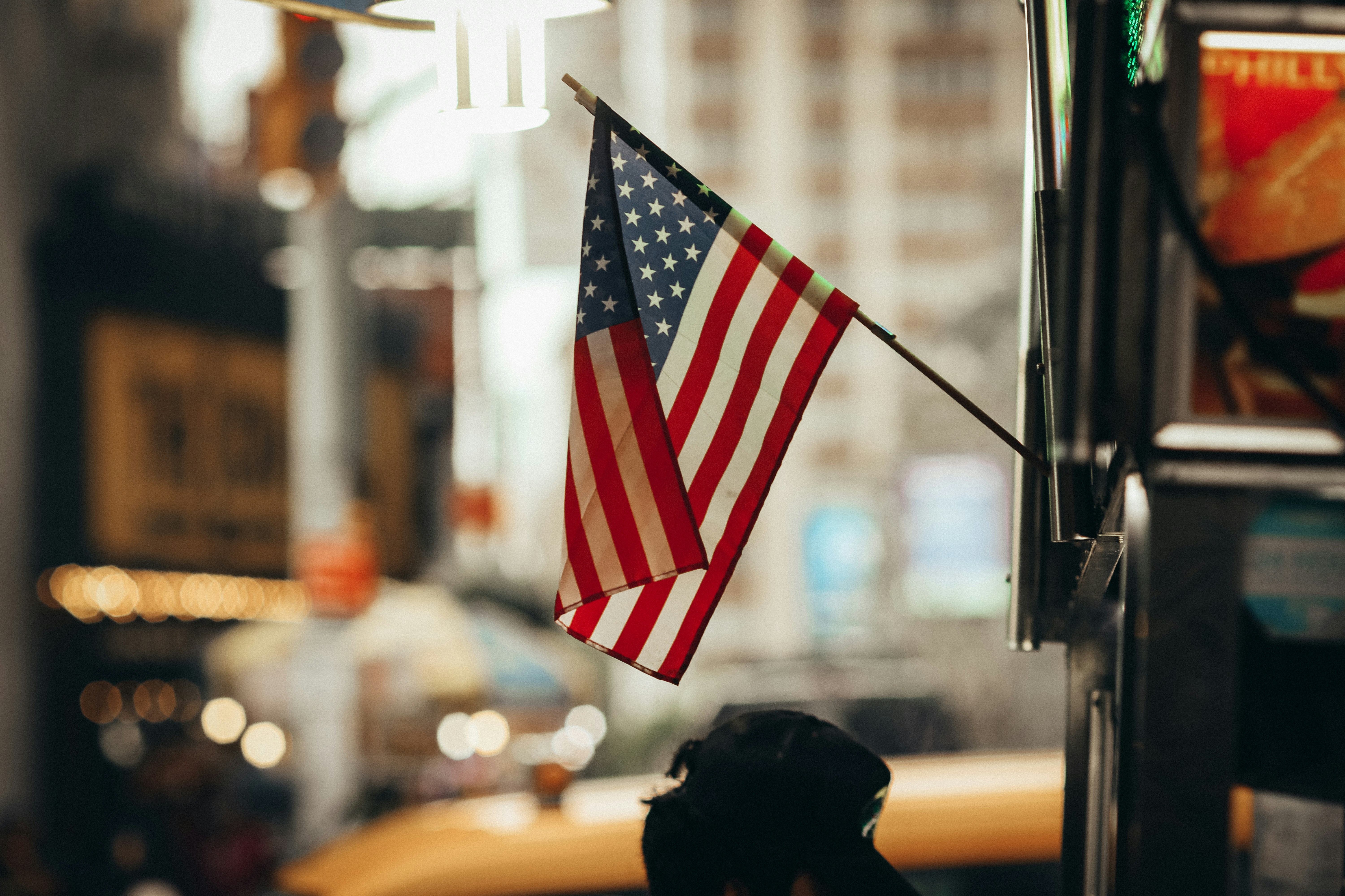 An american flag hanging from the side of a building photo – Free Flag ...