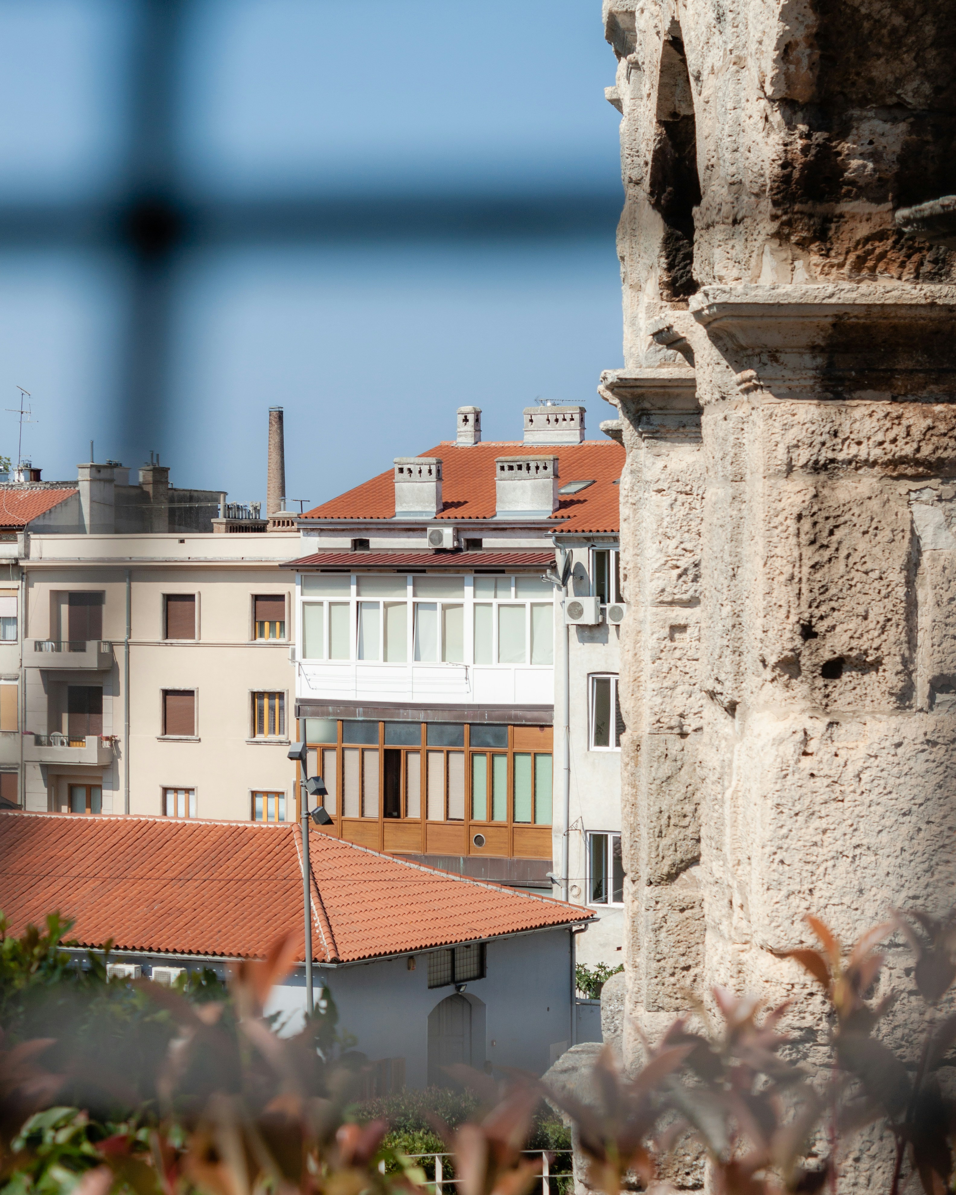 A view of a building through a window photo – Free Pula Image on Unsplash