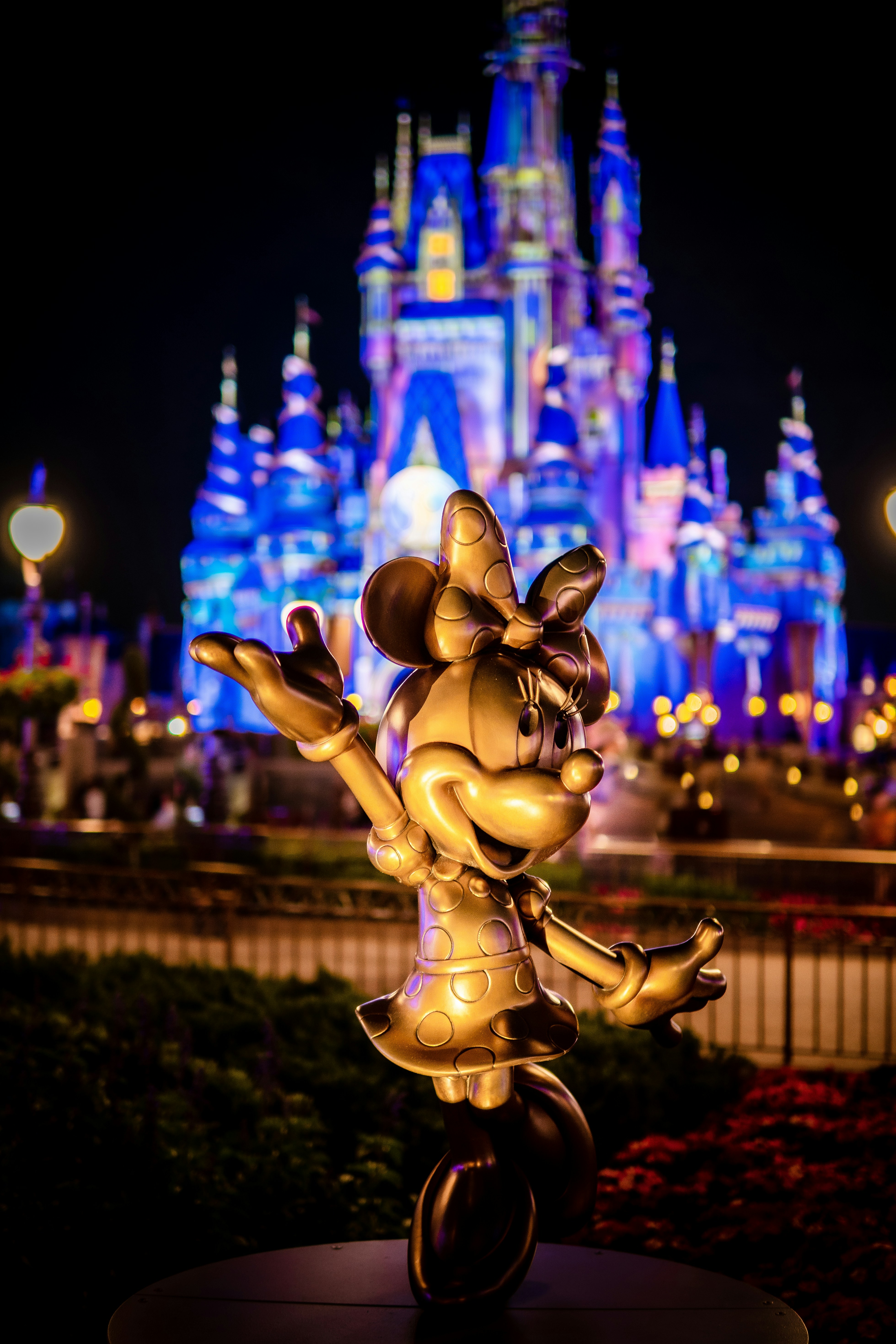 A statue of mickey mouse in front of a castle photo – Free Disney Image ...